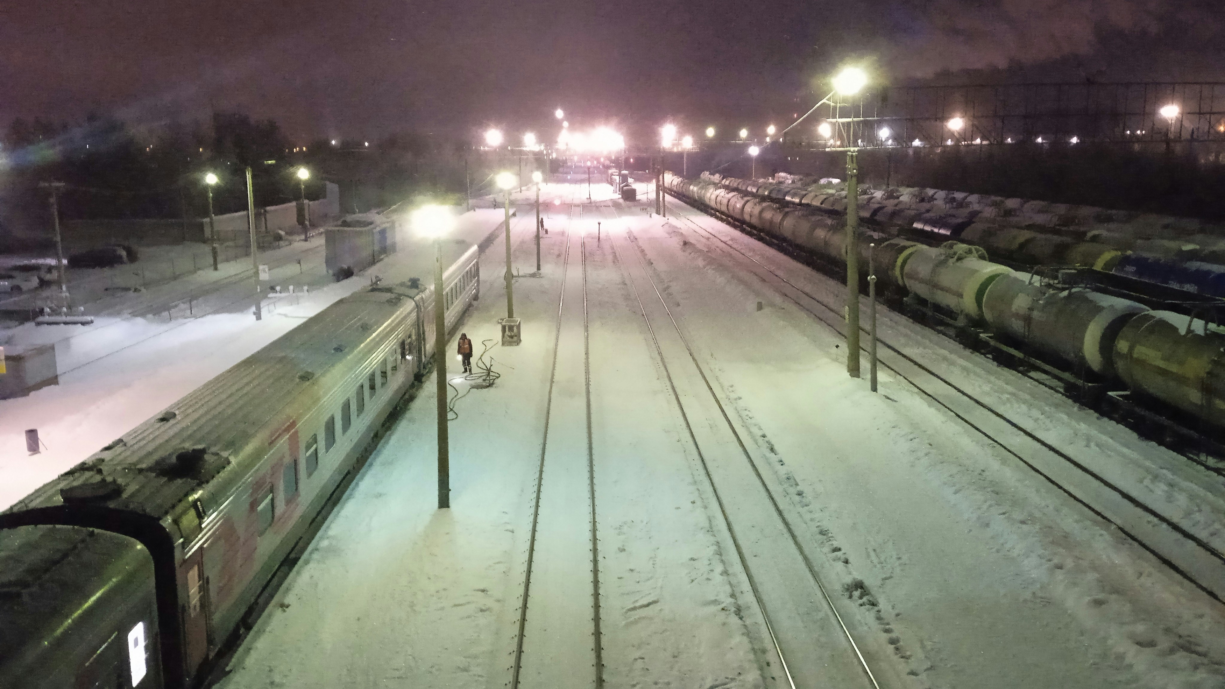 A train yard at night with snow on the ground photo – Free Terminal ...
