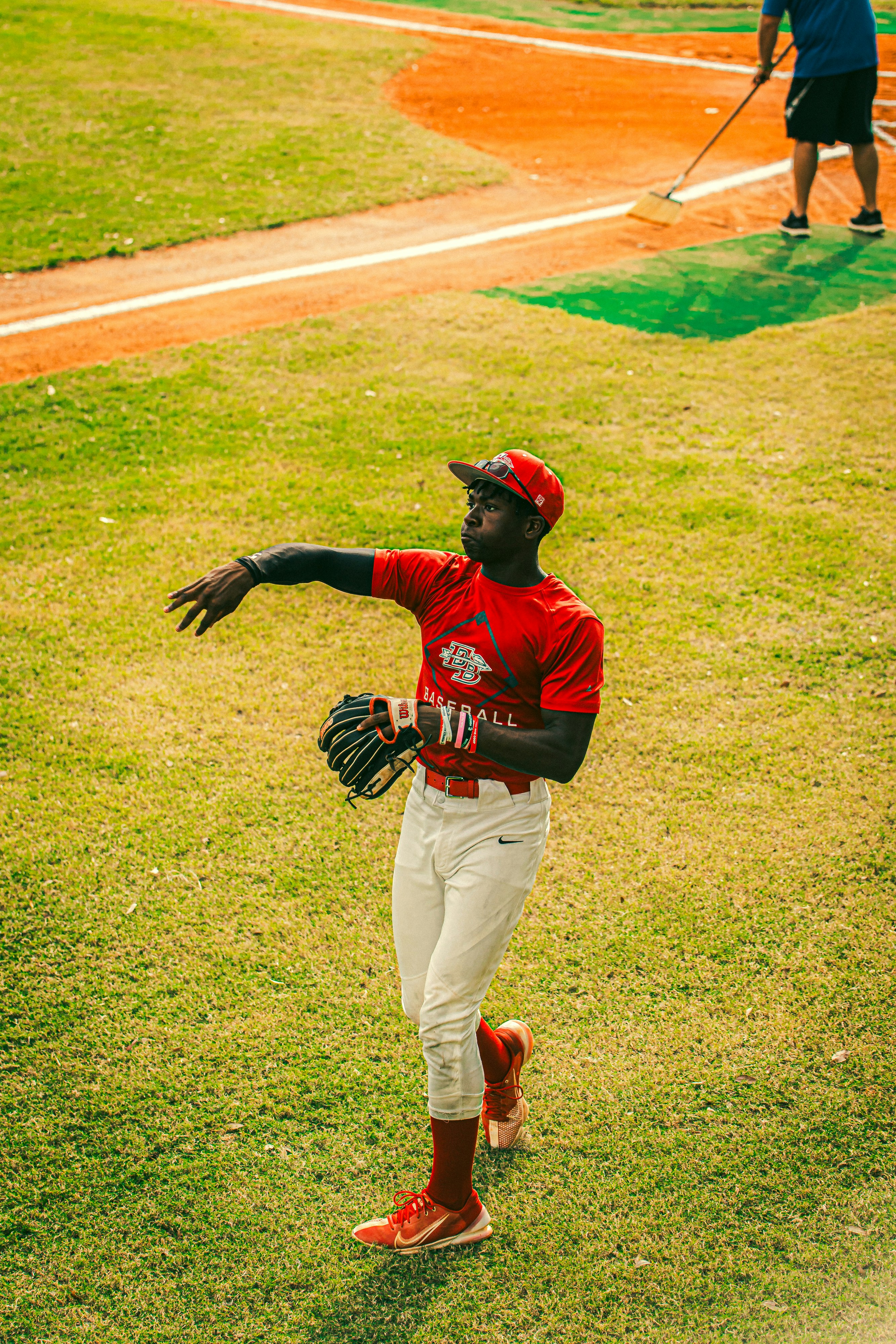 Red-Jersey Pitch: A Moment of Focus on the Sunlit Infield