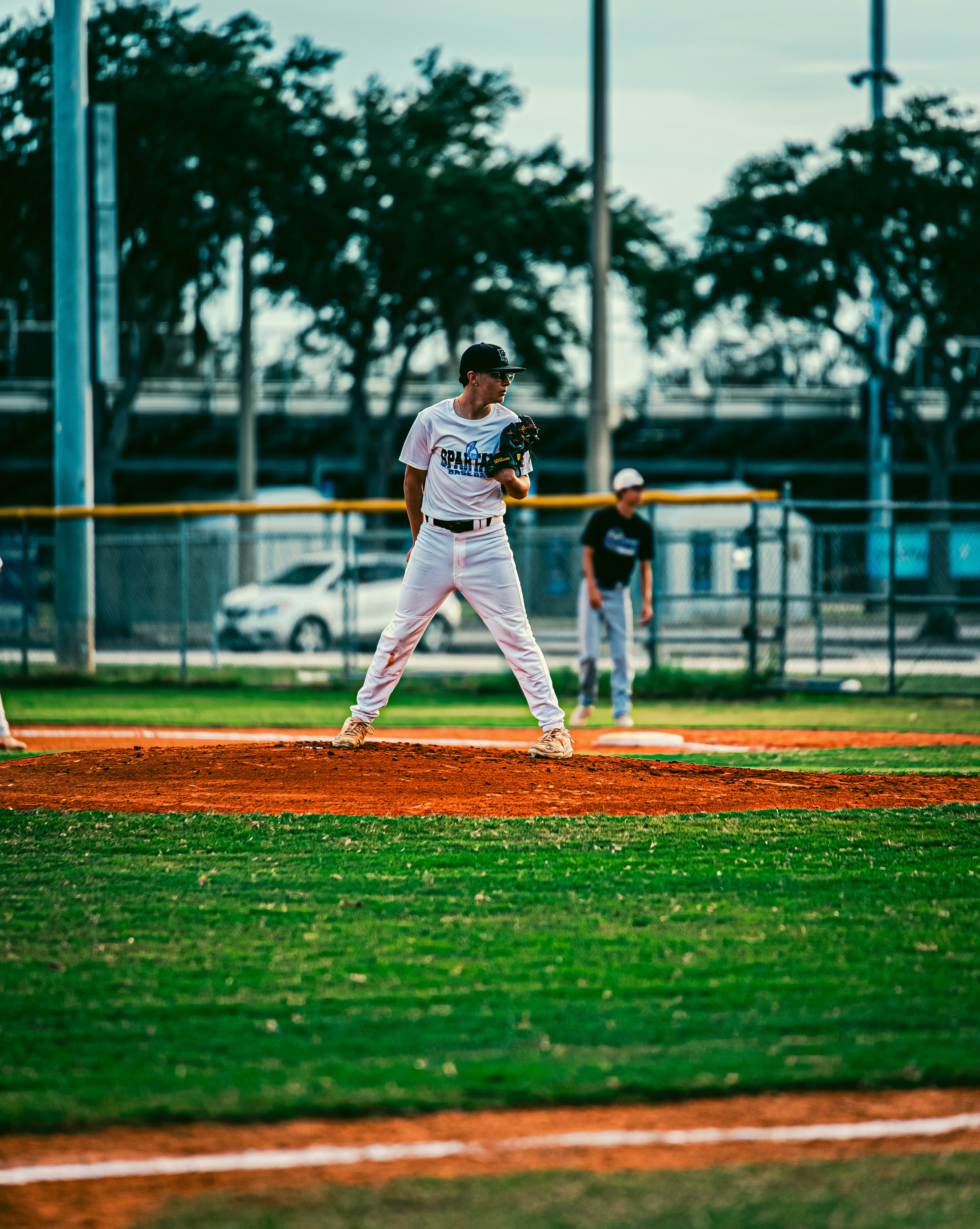 A baseball player standing on top of a field photo – Free Baseball ...