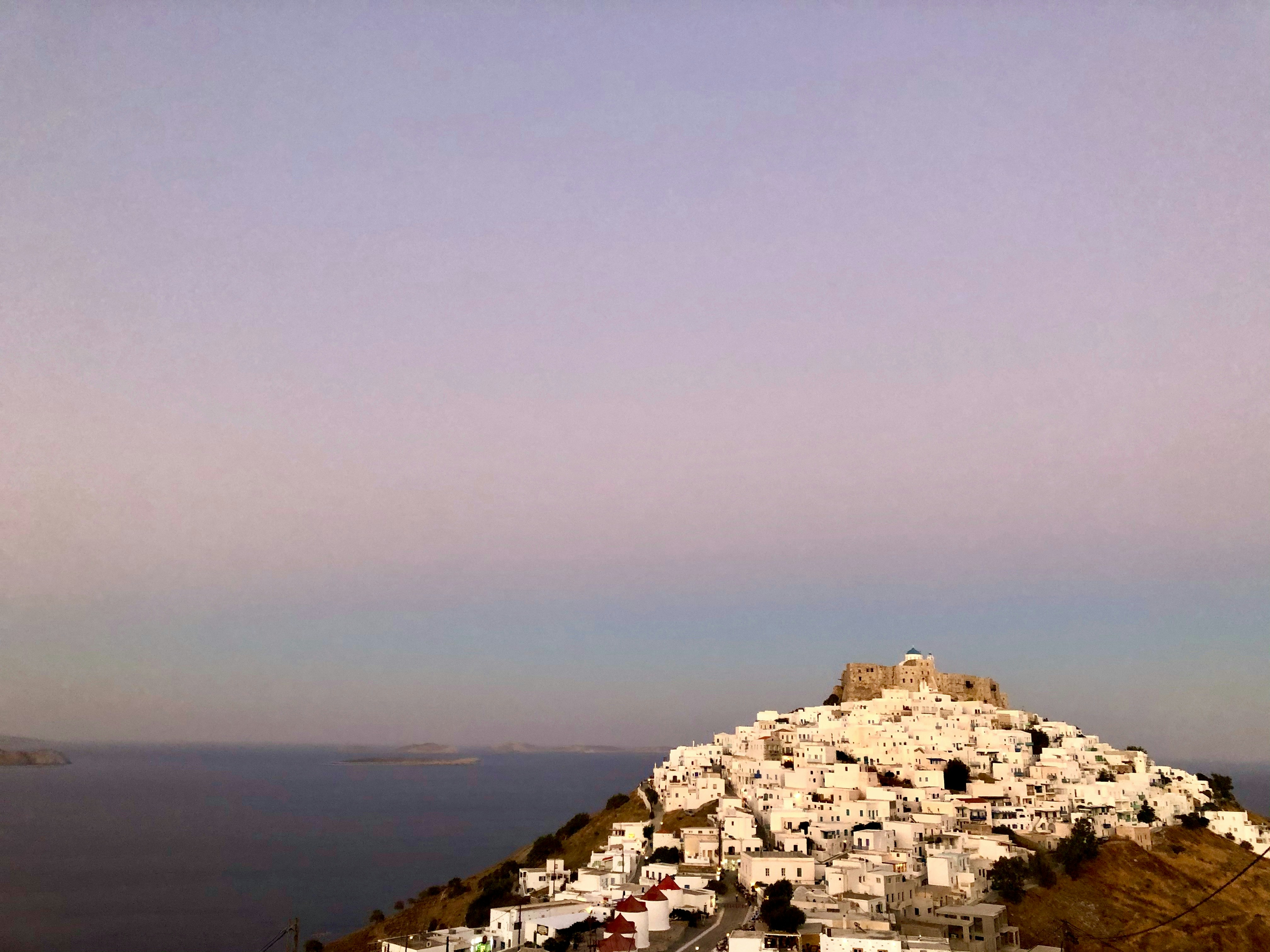Aegean Crest: Hilltop Fortress Above a Whitewashed Village at Dusk