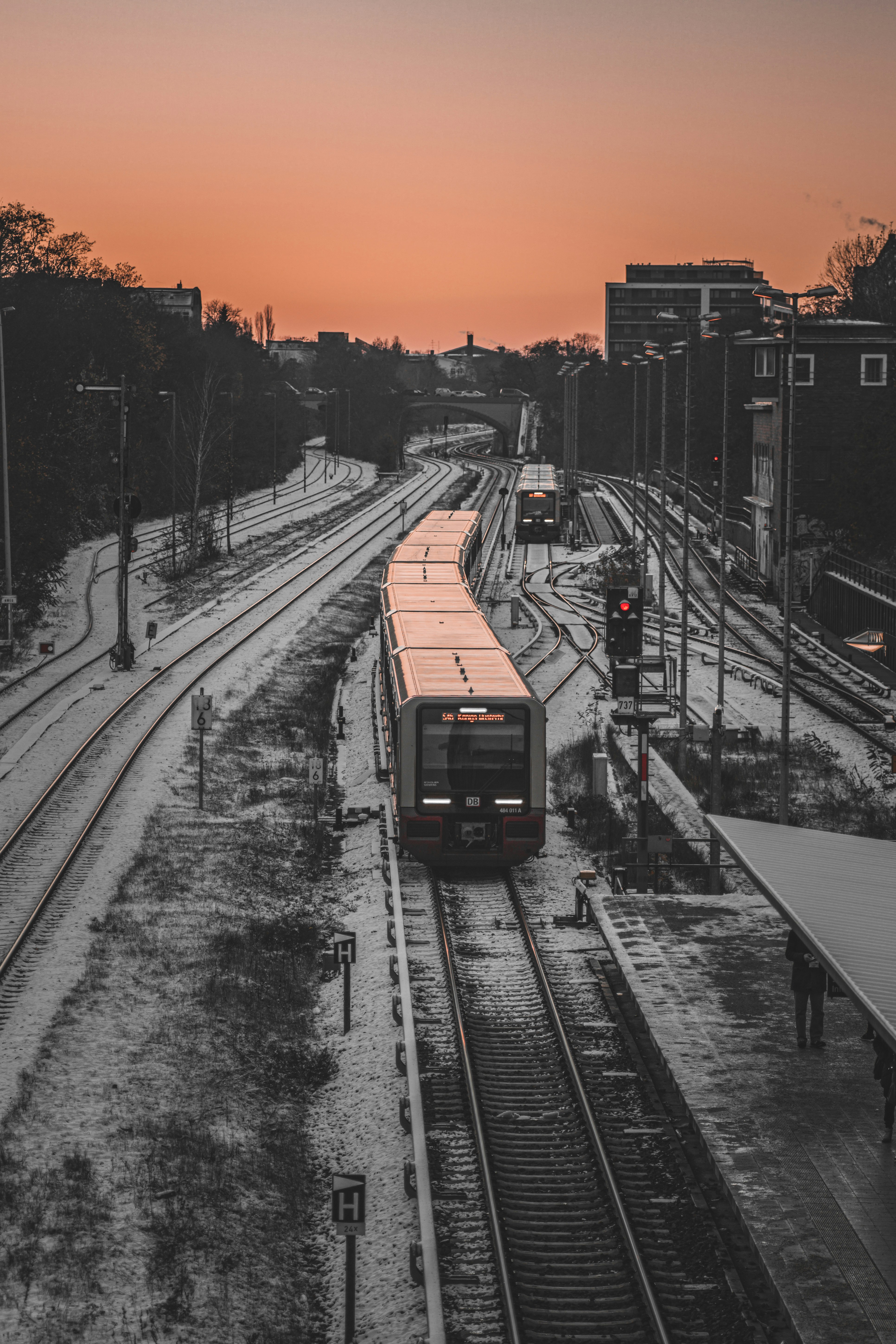 Sunset commuter: a lone train threading through a wintry cityscape