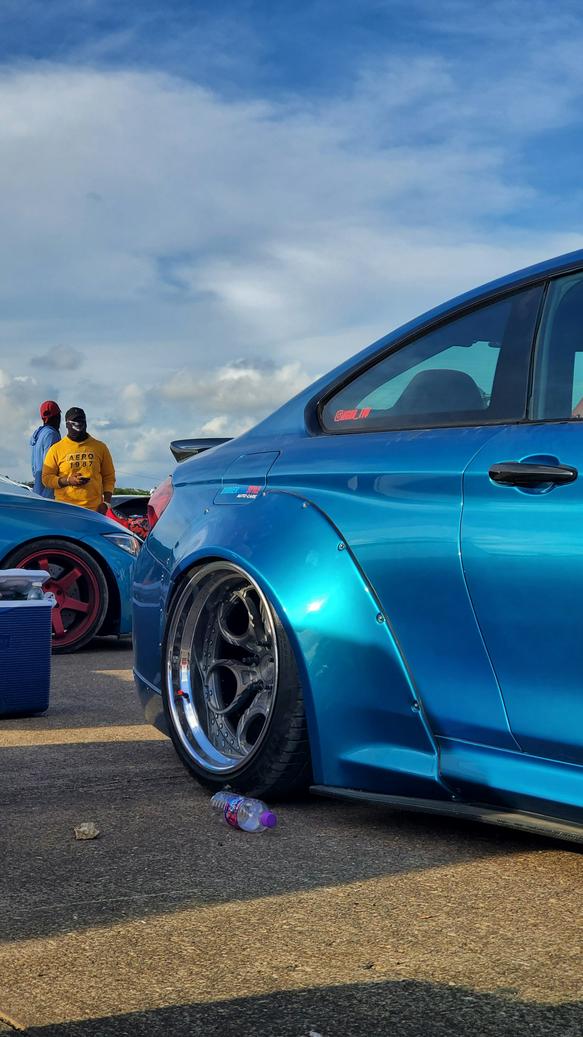Blue Stance: A Low-Slung Car Scene at the Park