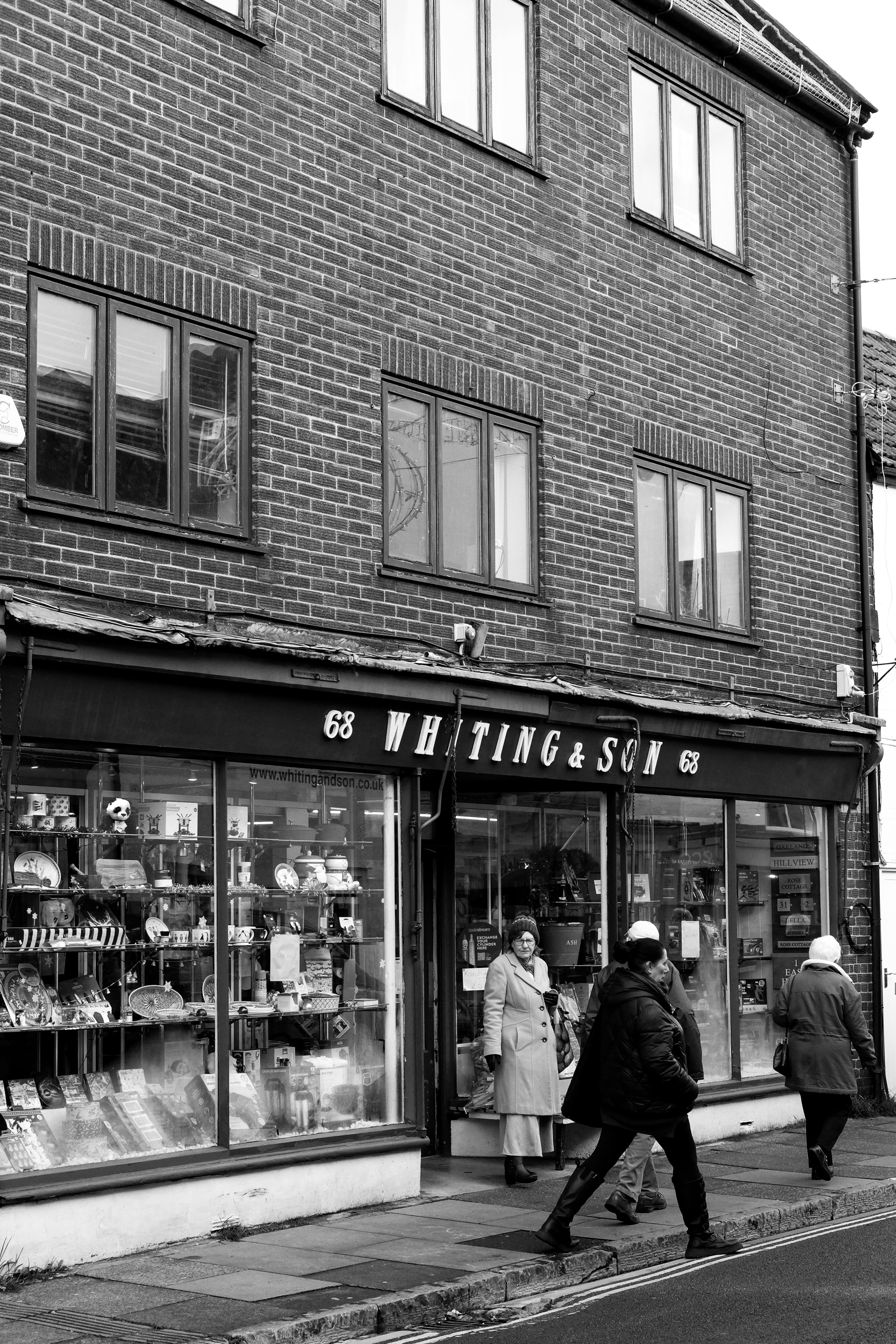 Whiting & Son | a black and white photo of a store front