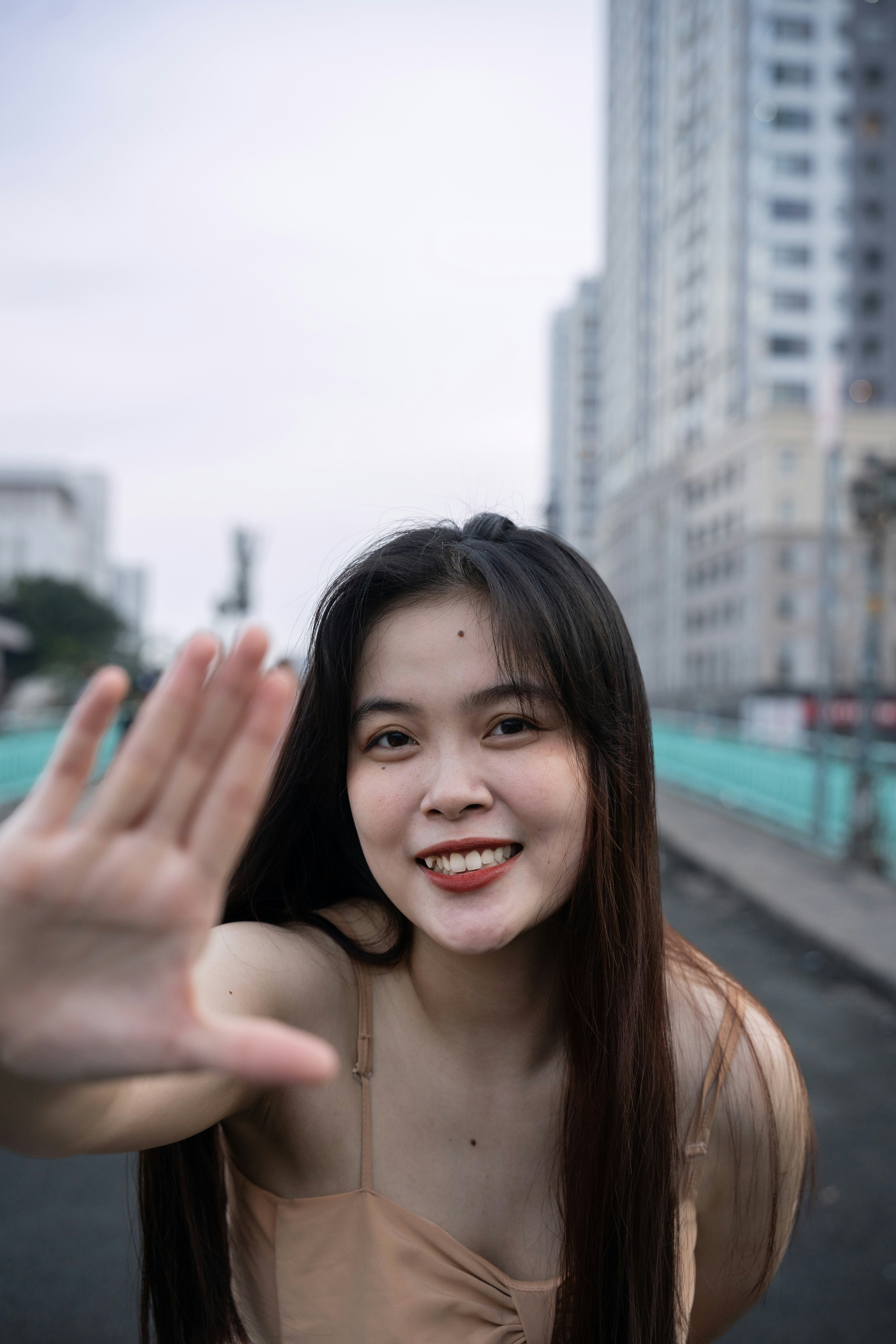 Hello to the City: A Candid Portrait on an Urban Bridge.