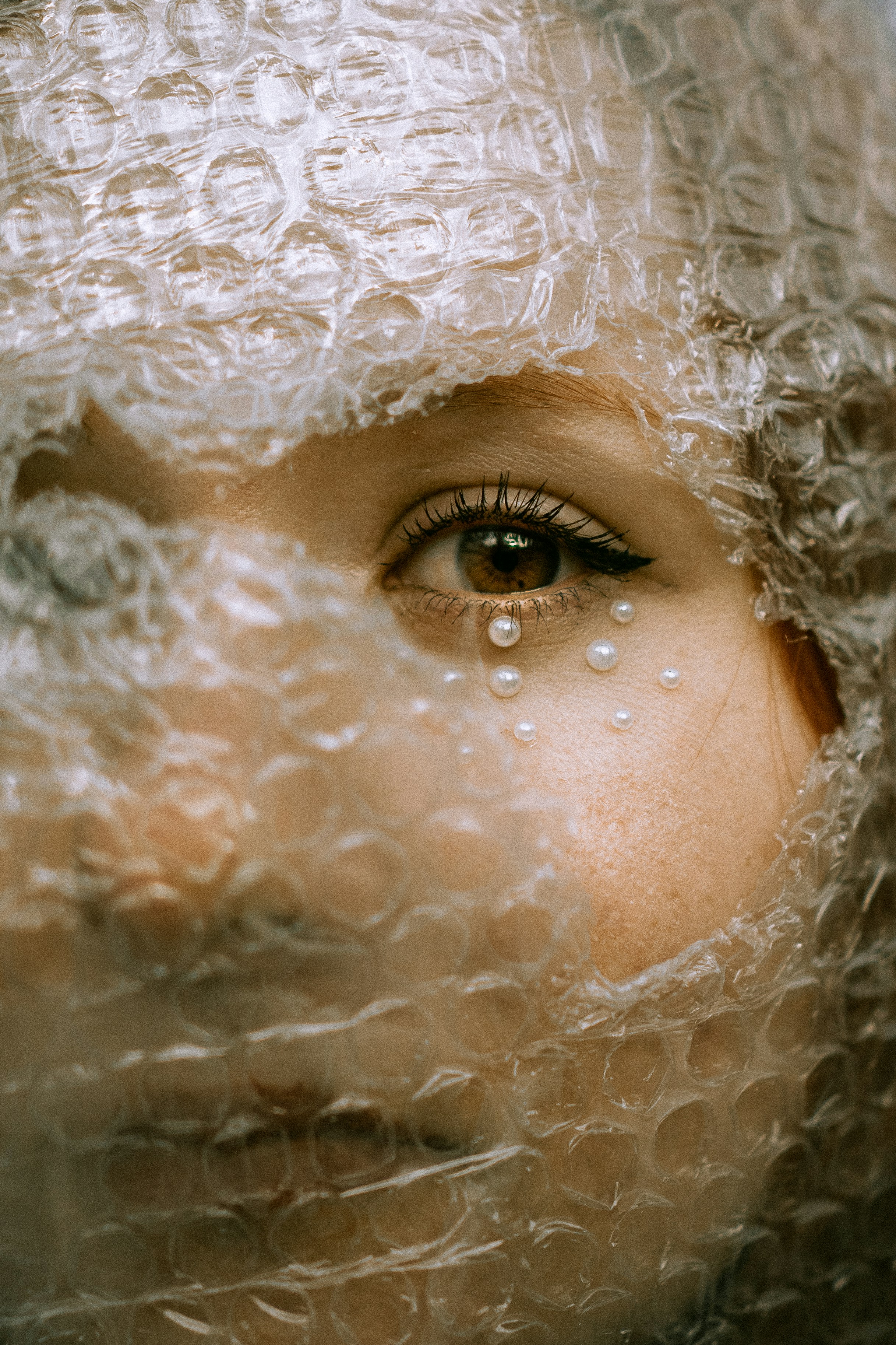A close up of a woman's face covered in plastic photo – Free Ankara ...