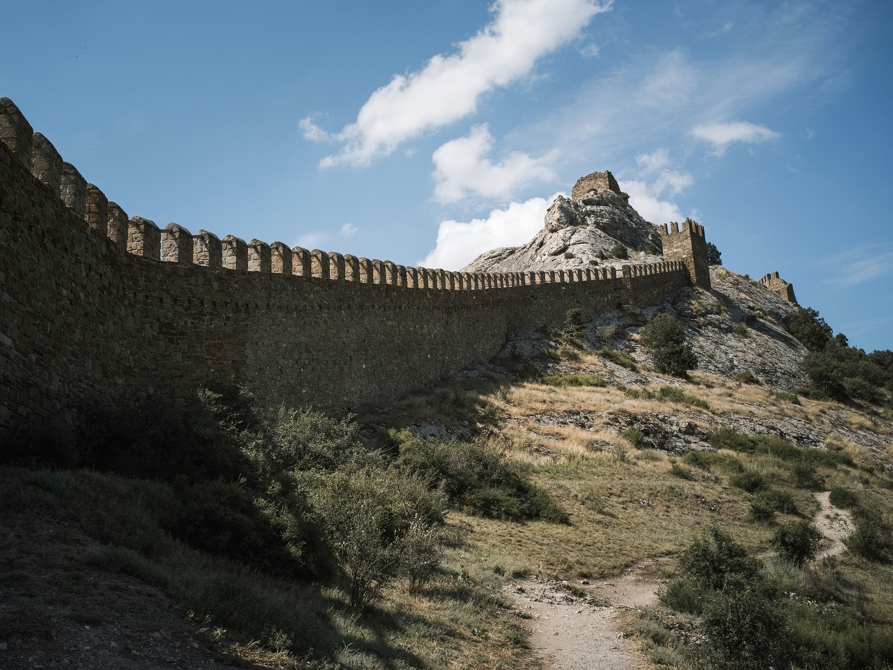 A large stone wall on top of a hill photo – Free Sudak Image on Unsplash