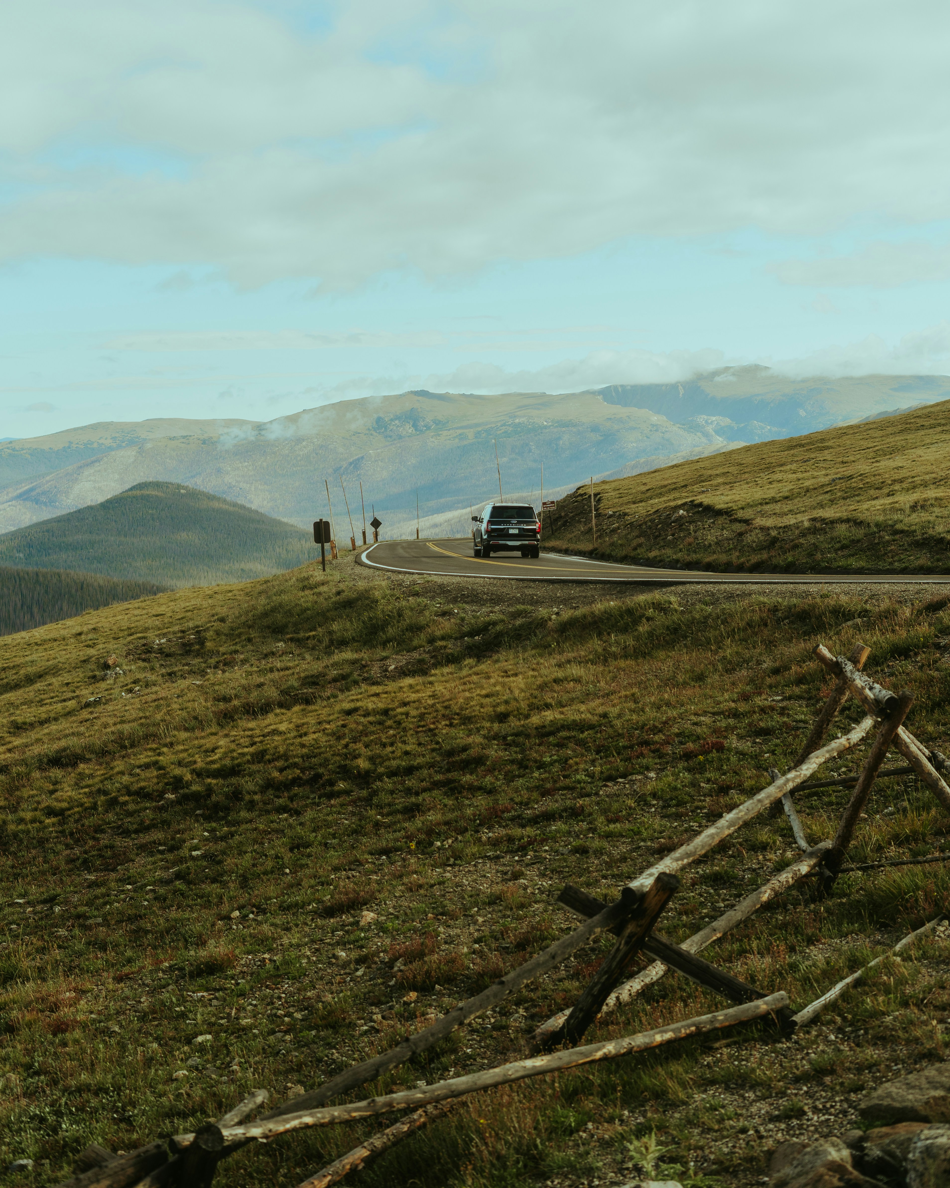 A Lone SUV Negotiates a Winding Highland Road