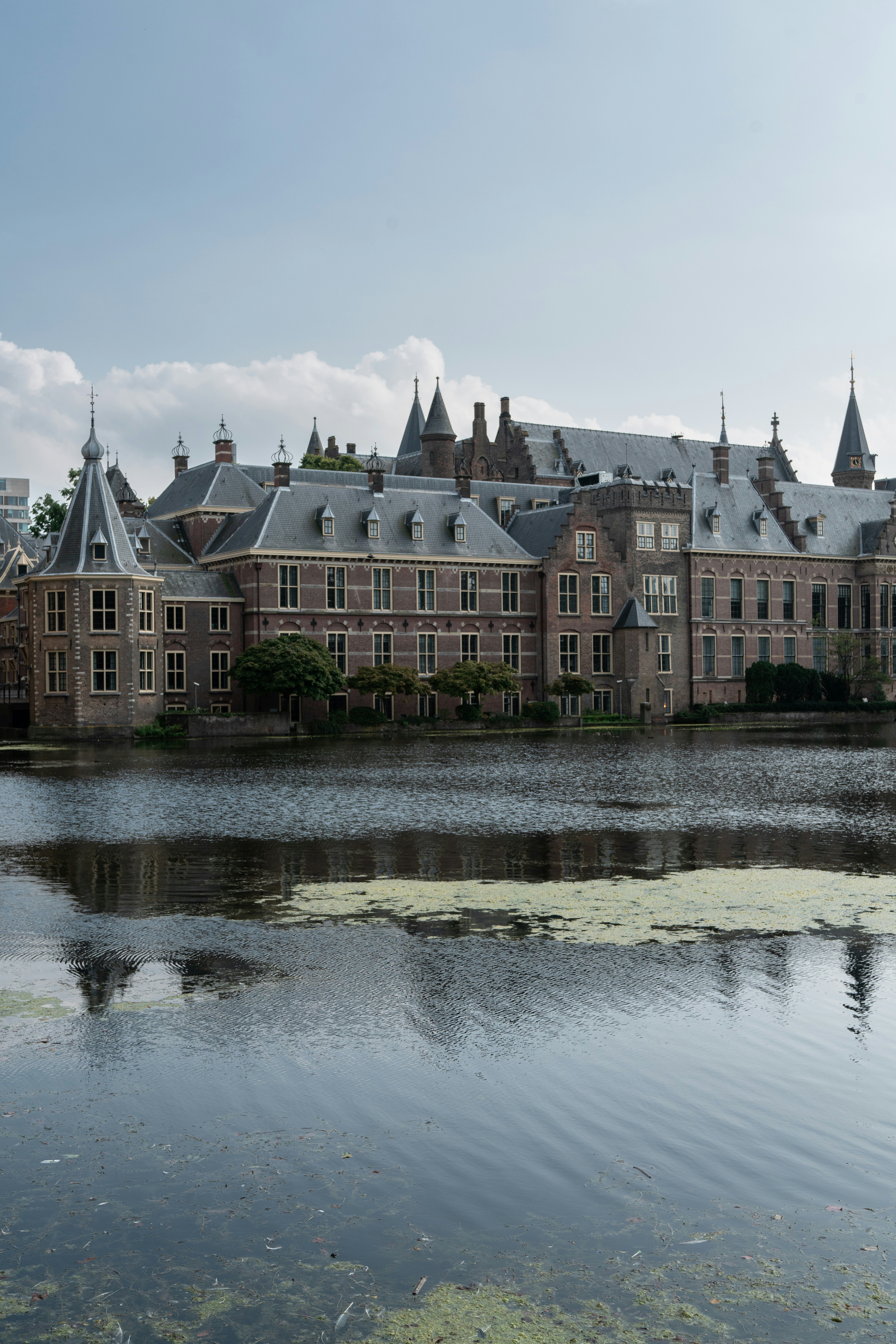 Riverside Château: Slate-Roofed Facades Mirror a Tranquil Canal