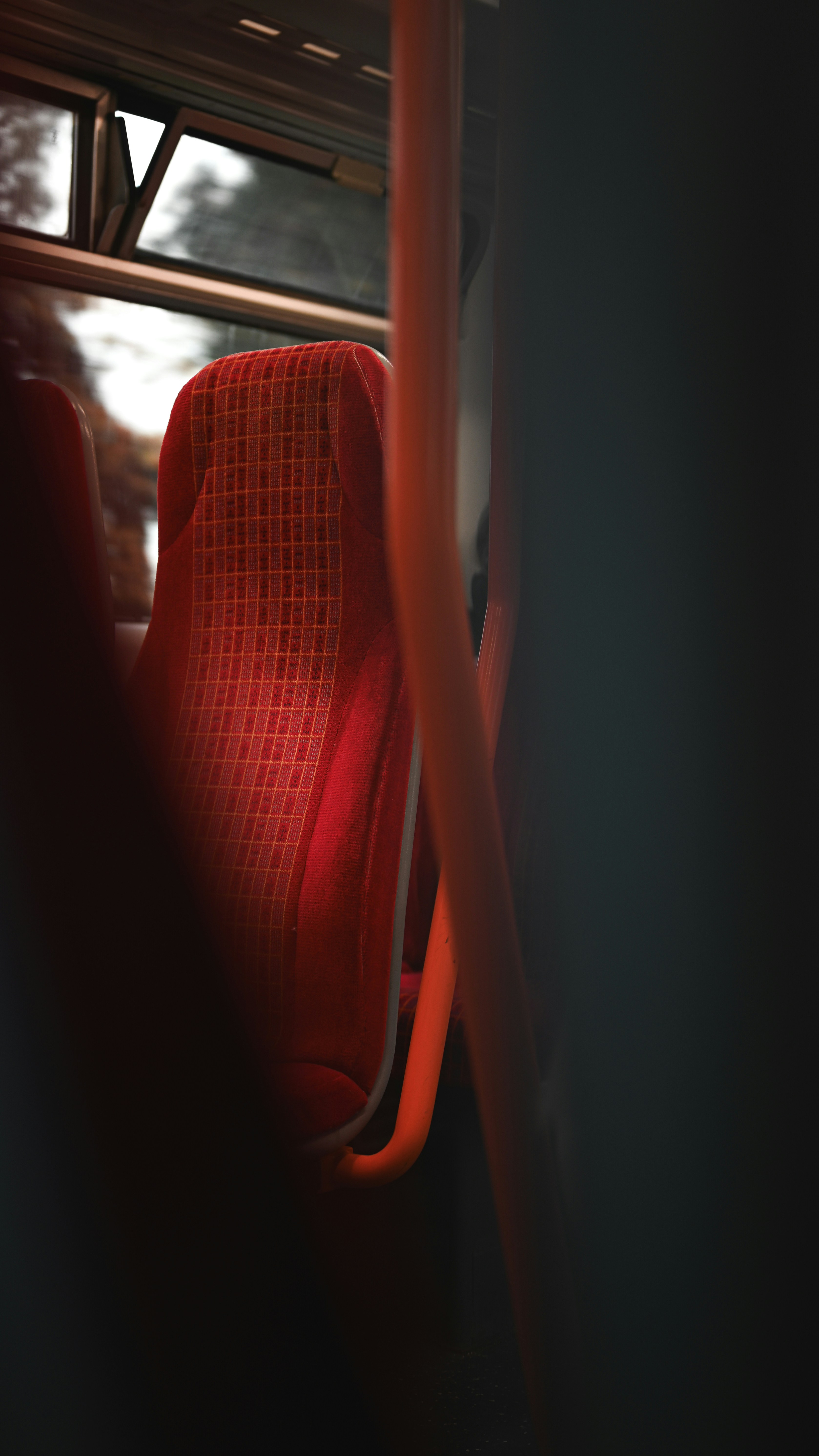 A red seat on a bus in the dark photo – Free London Image on Unsplash