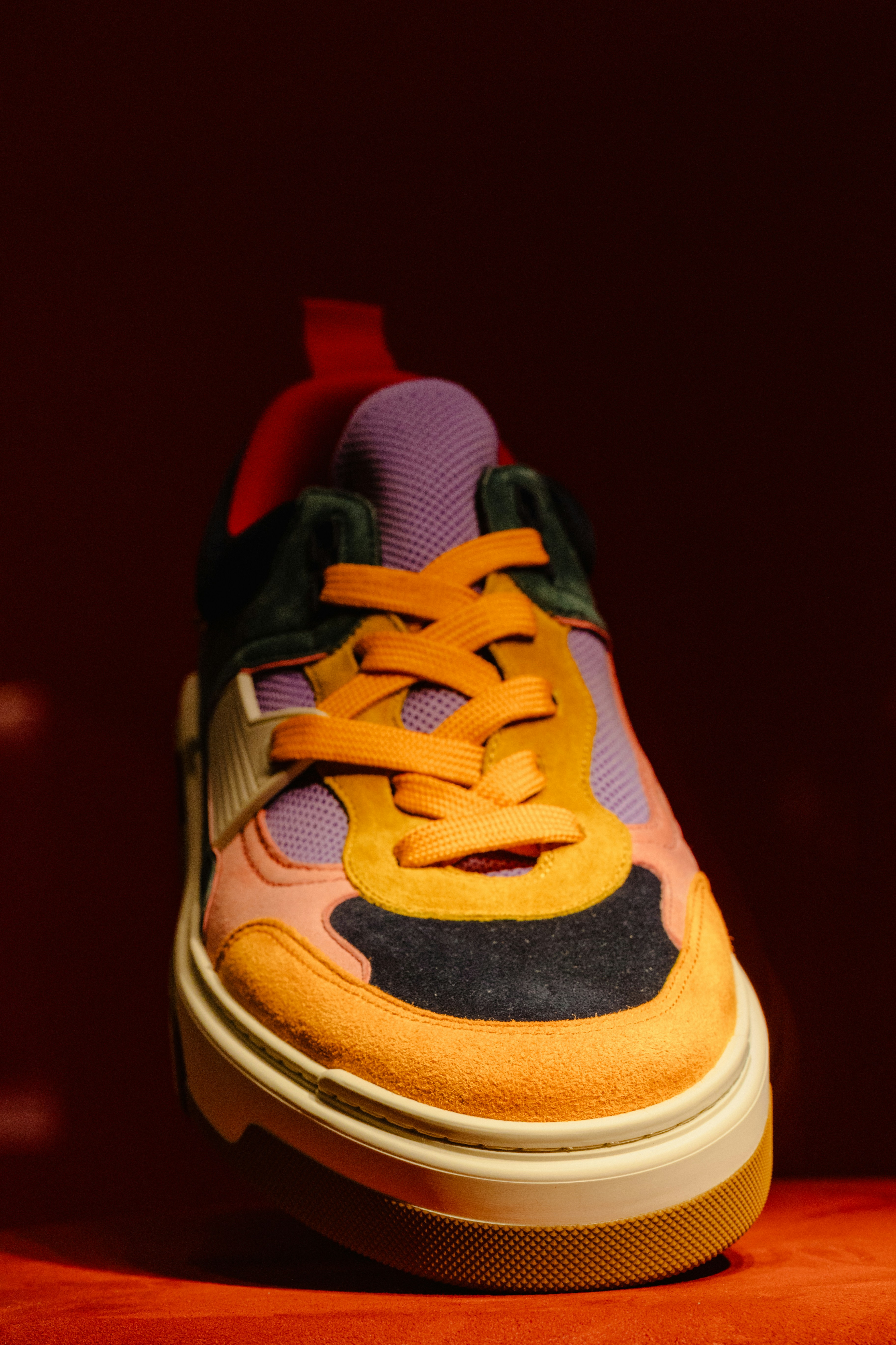 A pair of colorful sneakers on a red surface photo – Free Shoe Image on ...