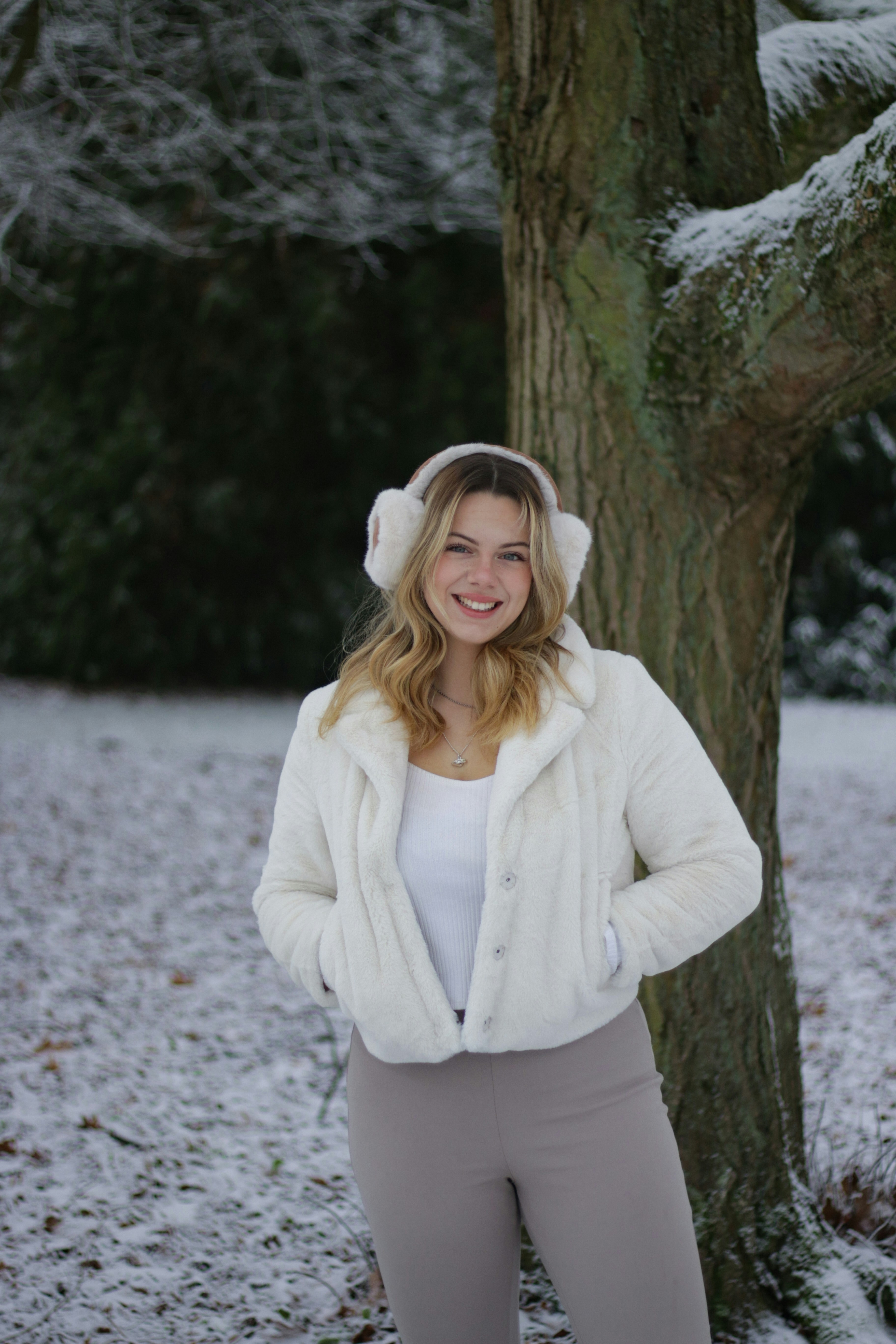 Winter Warmth: A Luminous Portrait Beneath Snow-Kissed Pines