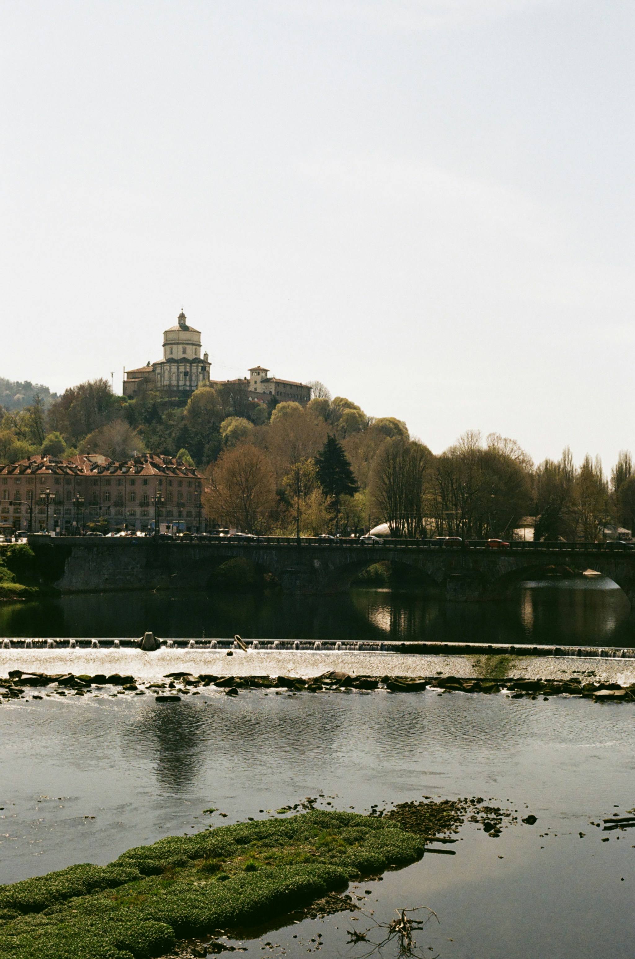Serene Riverside Vista with Hilltop Architecture