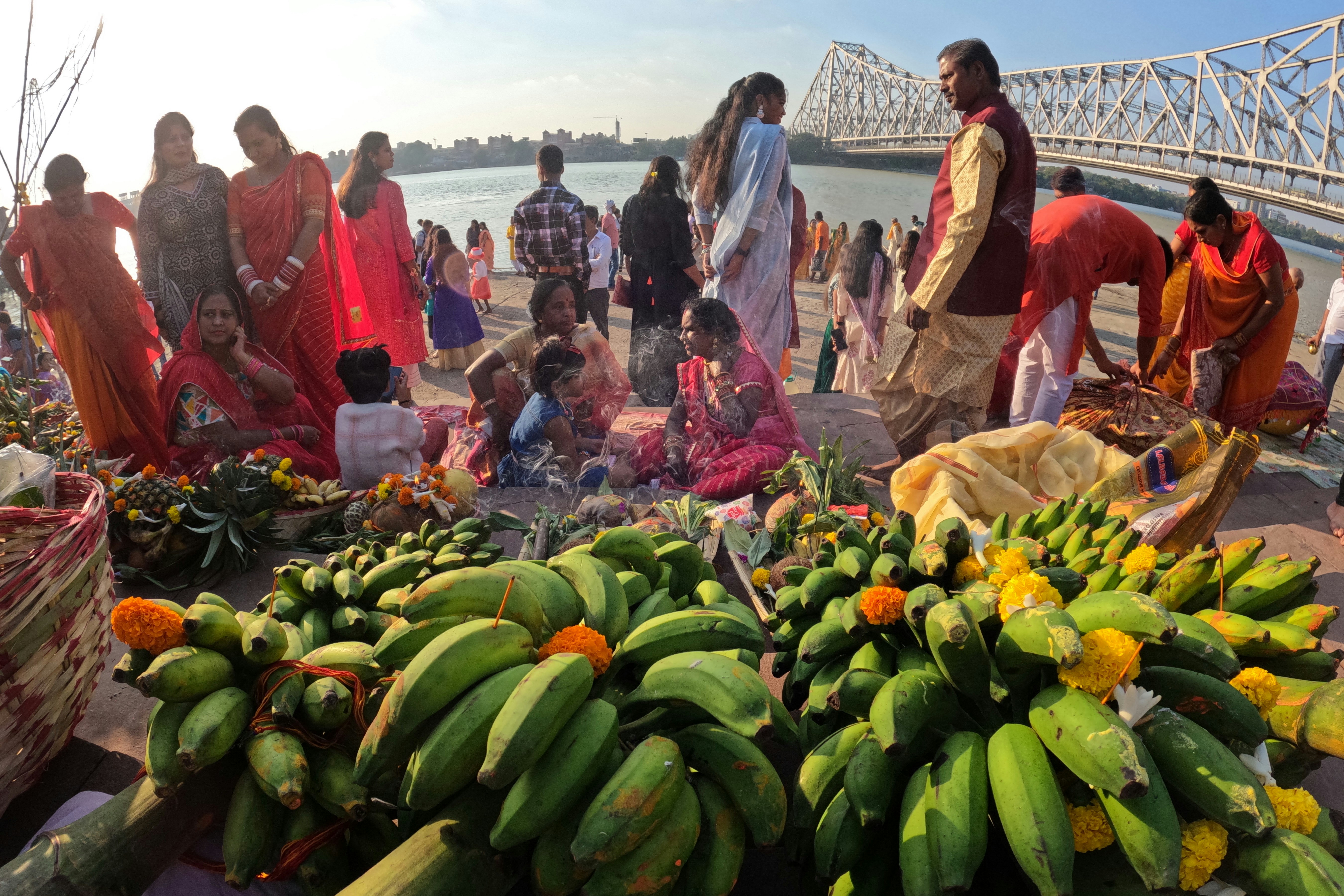 Vibrant Riverside Market: Mangoes and Ceremony by the Bridge