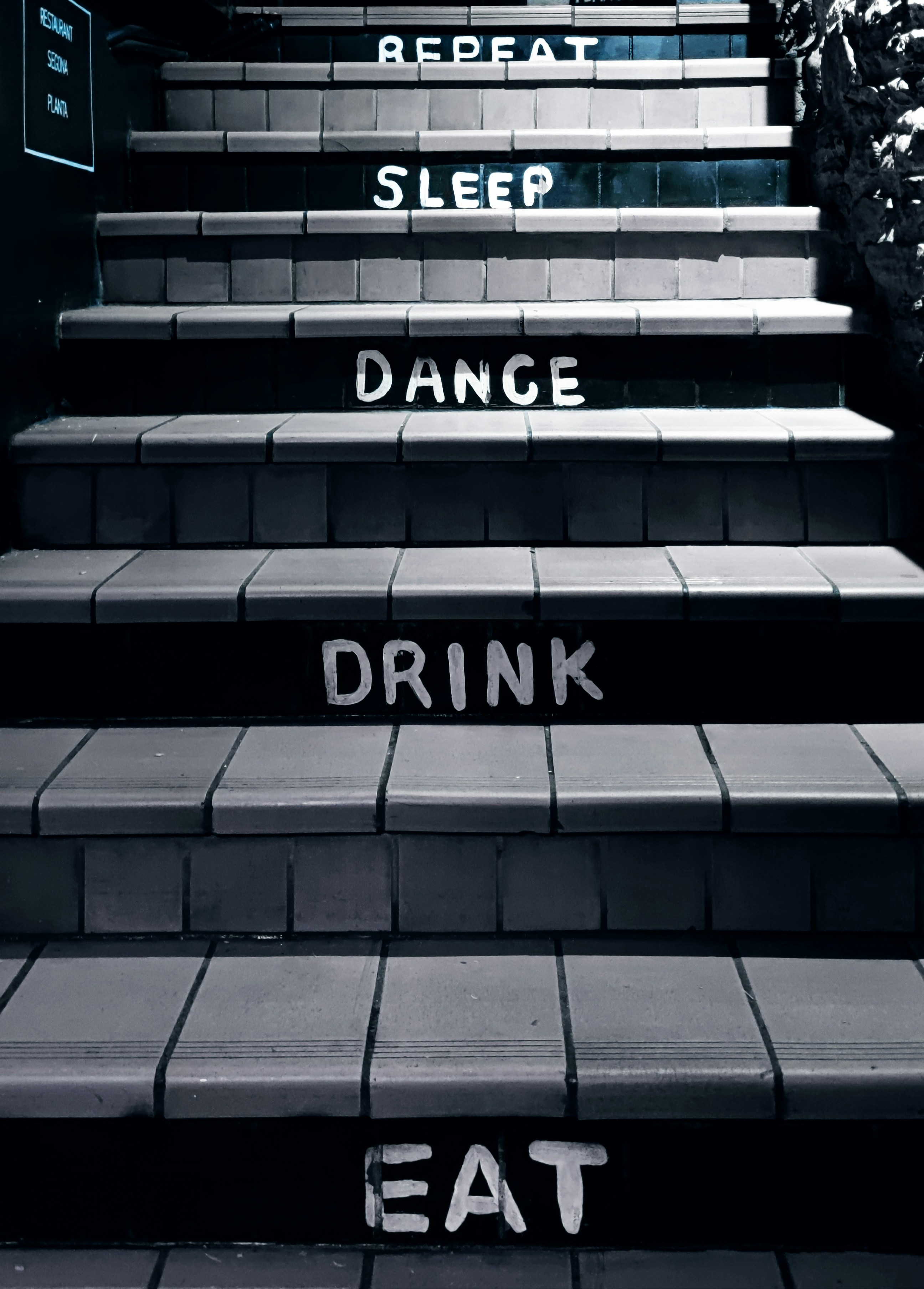 A black and white photo of a set of stairs with the words eat sleep ...