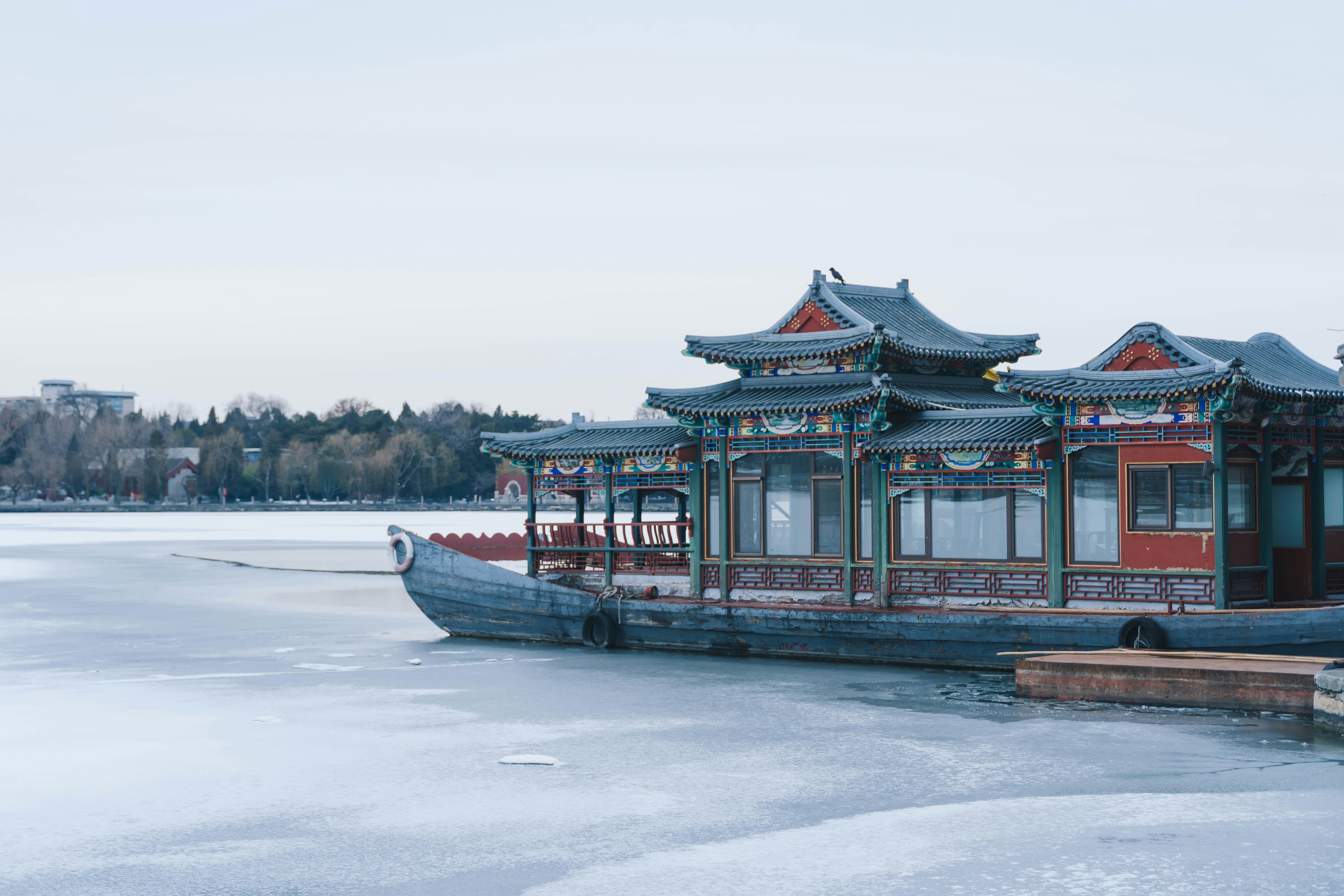 Icebound Lanterns: An Ornate Chinese Pavilion Resting on a Frozen Lake