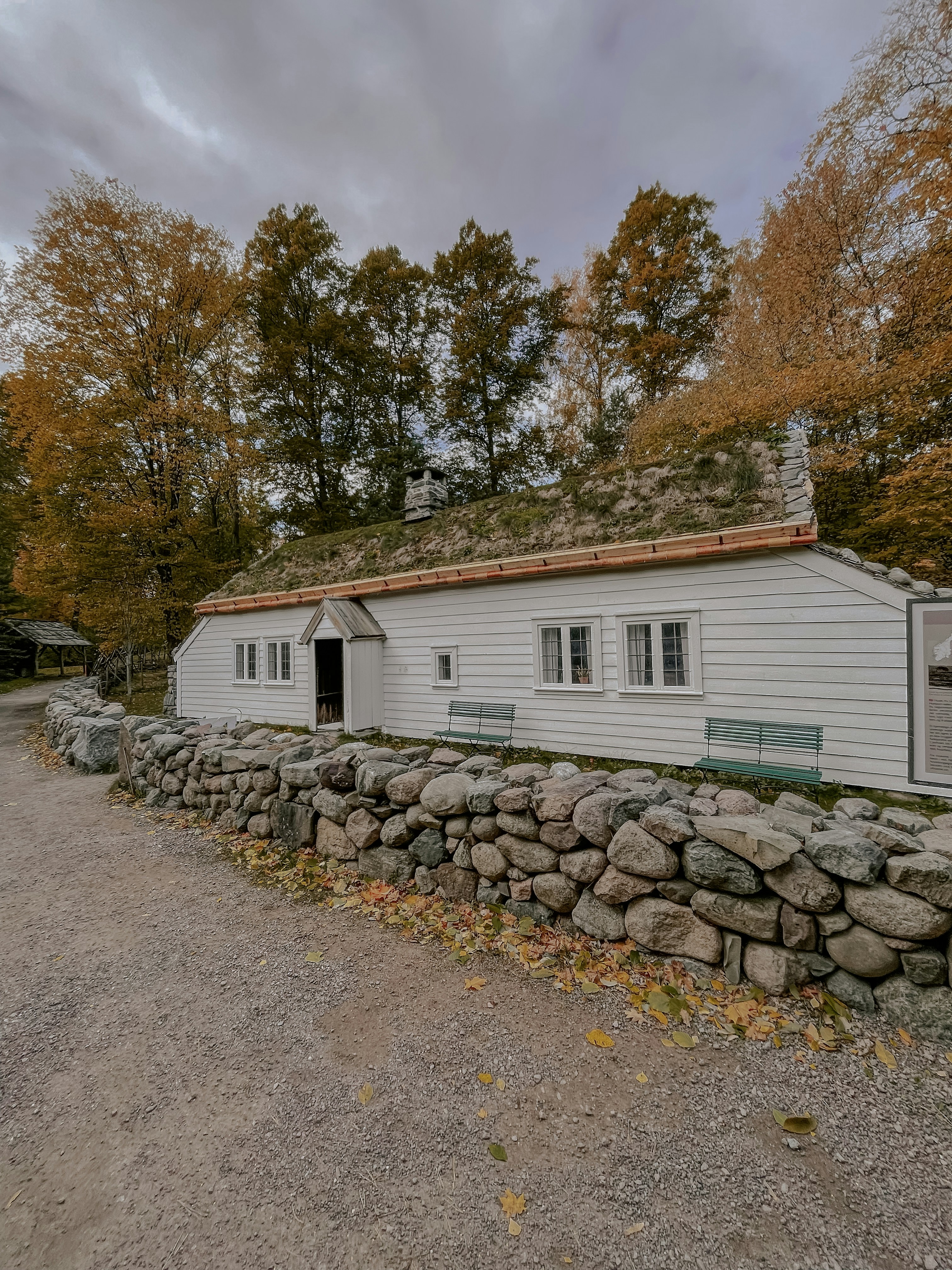 Fieldstone Wall and White Cabin Under an Autumn Canopy