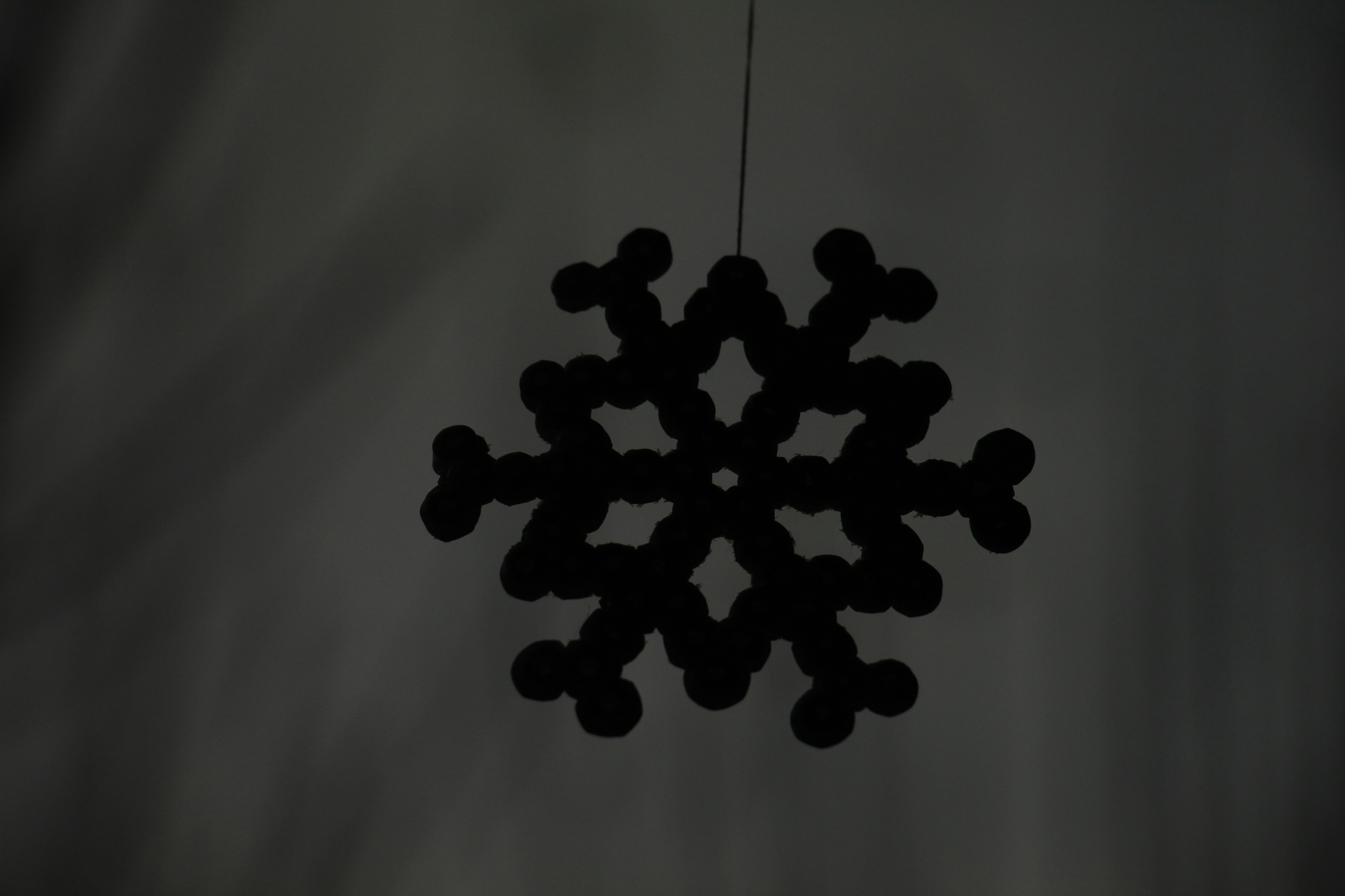 Hanging Snowflake Silhouette in a Velvet Gray Backdrop