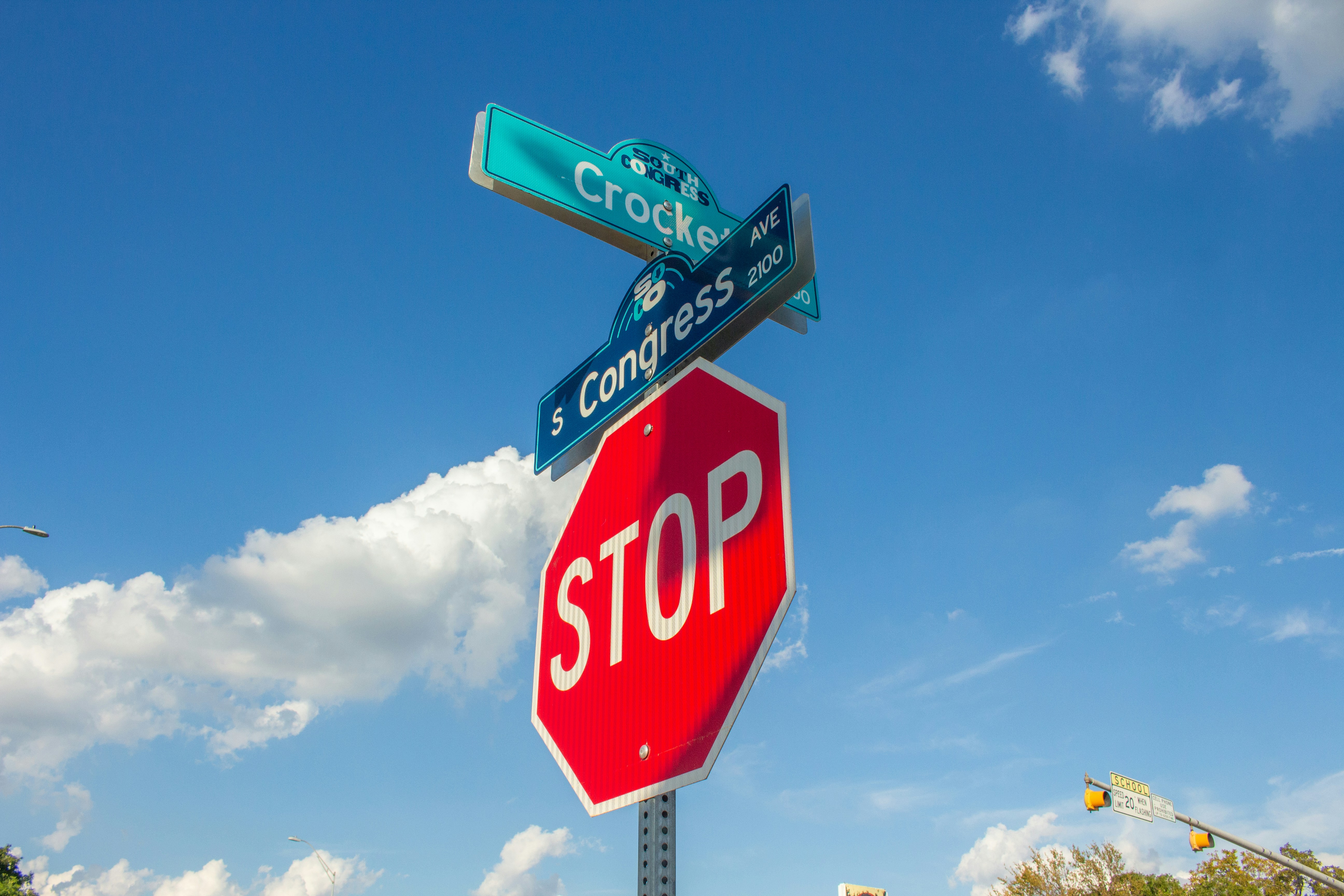 A stop sign with street signs on top of it photo – Free Austin Image on ...
