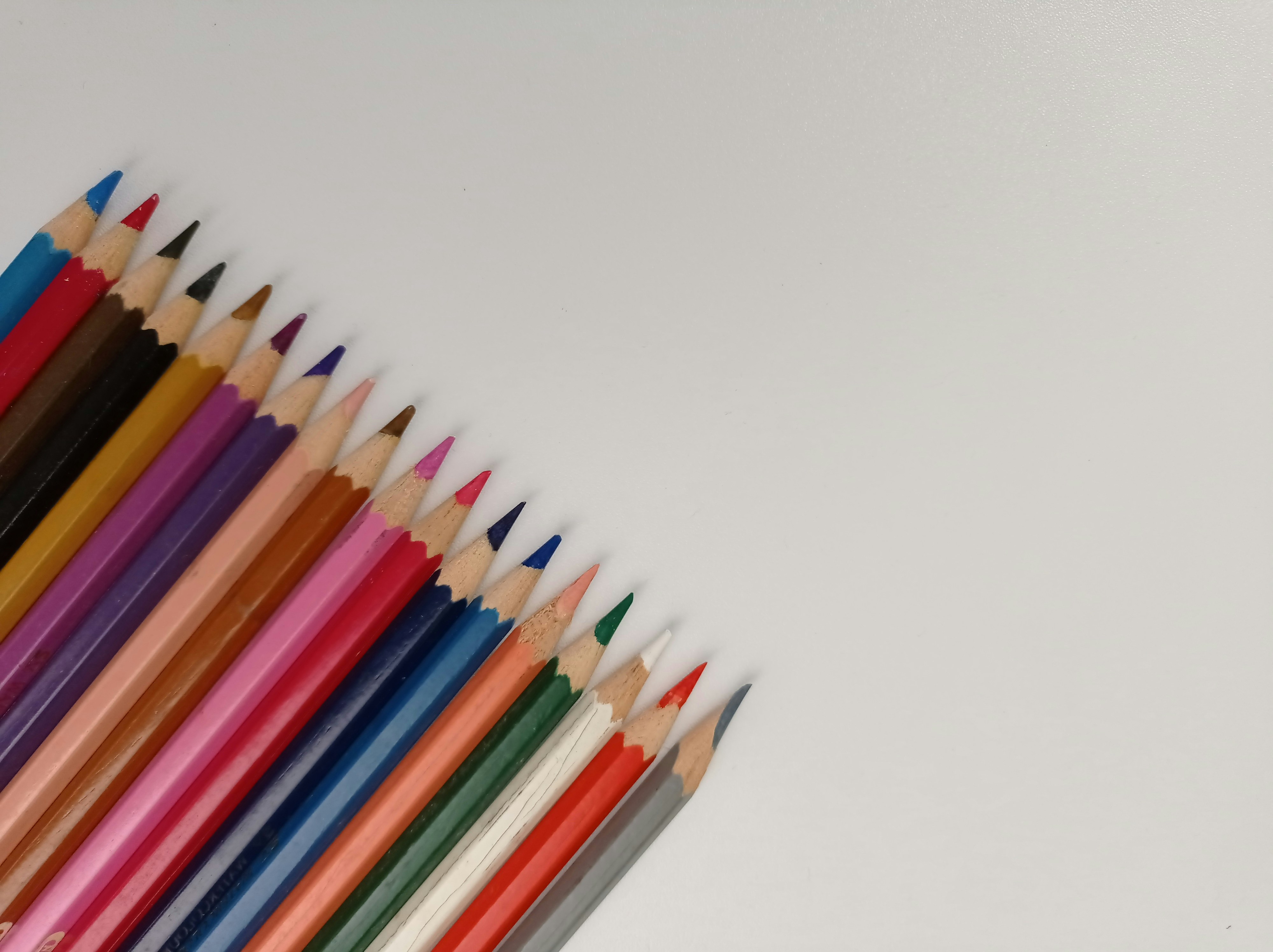 A group of colored pencils lined up in a row photo – Free Pencil Image ...