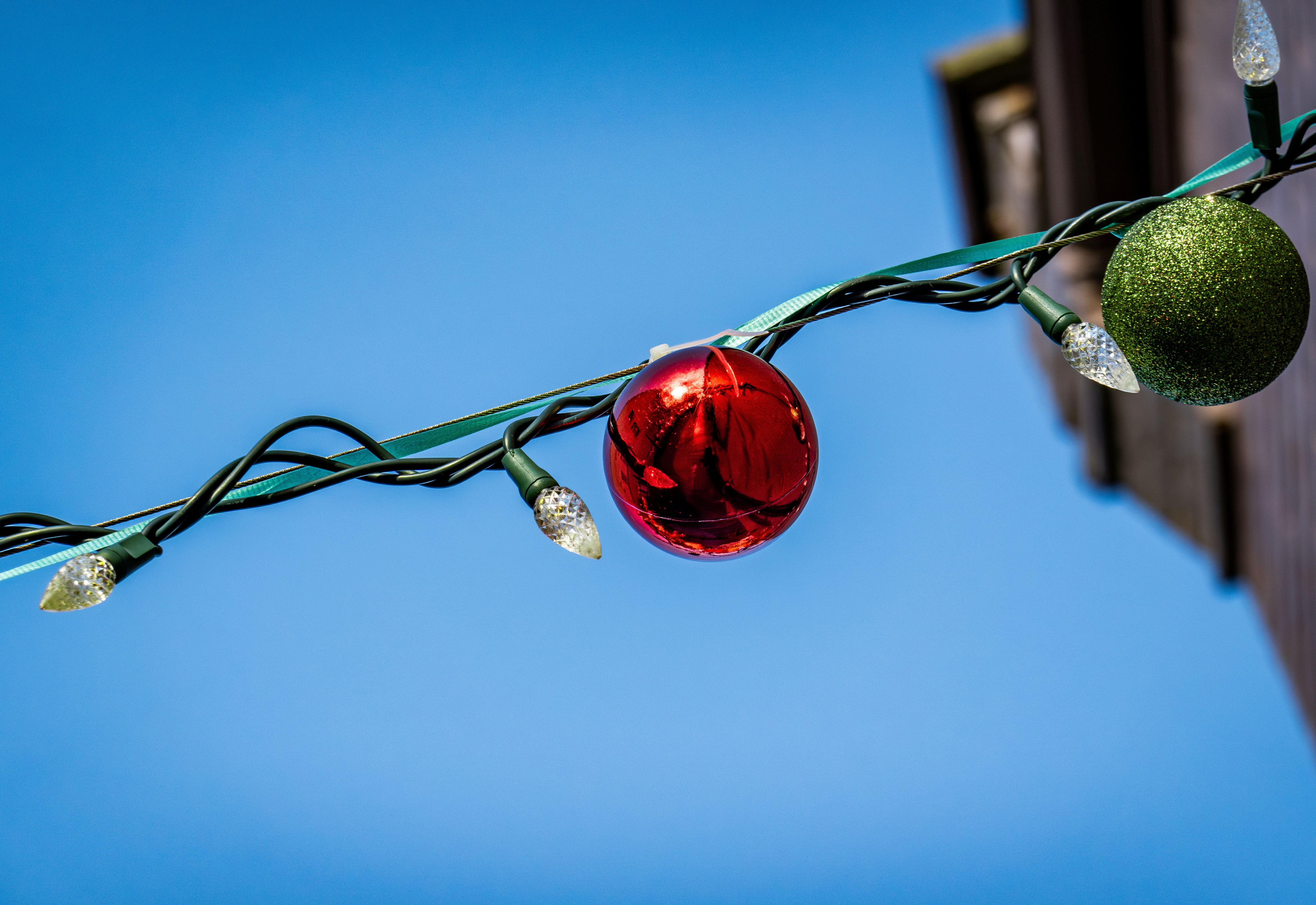 Crimson Globe on a Cerulean Sky: Holiday Lights in Focus