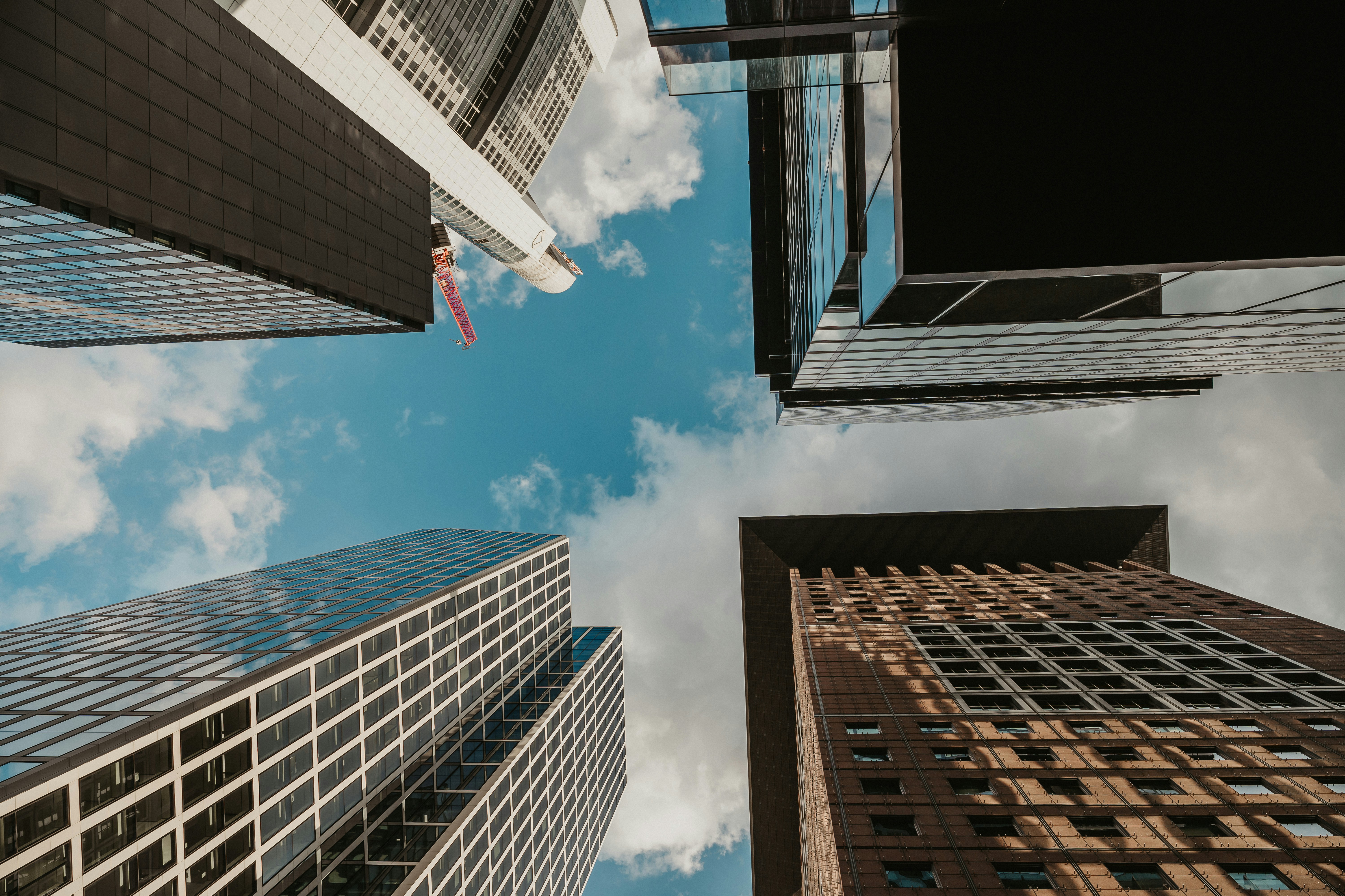 Looking up at tall buildings in a city photo – Free Blue Image on Unsplash