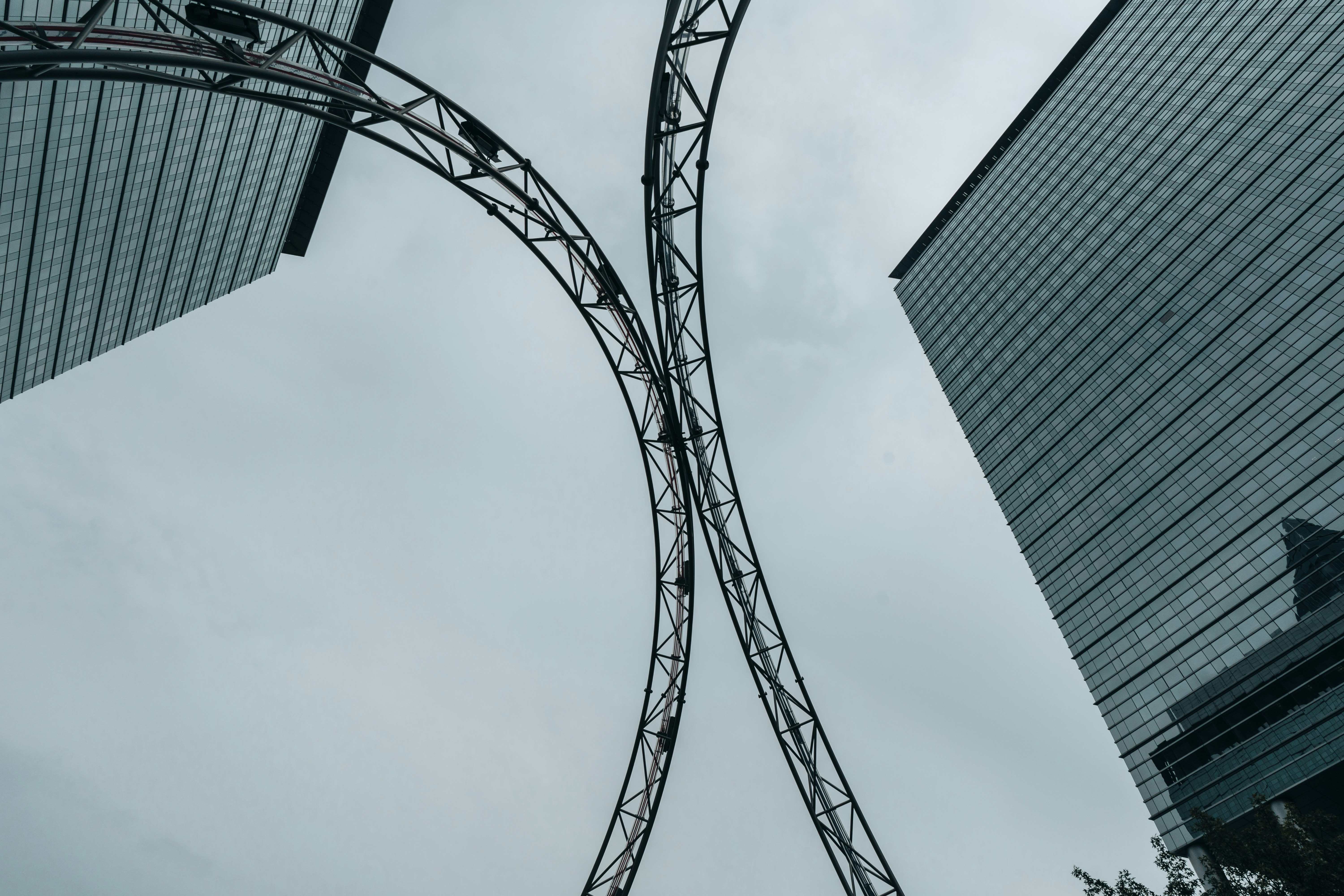 A roller coaster going through a city with tall buildings photo – Free ...