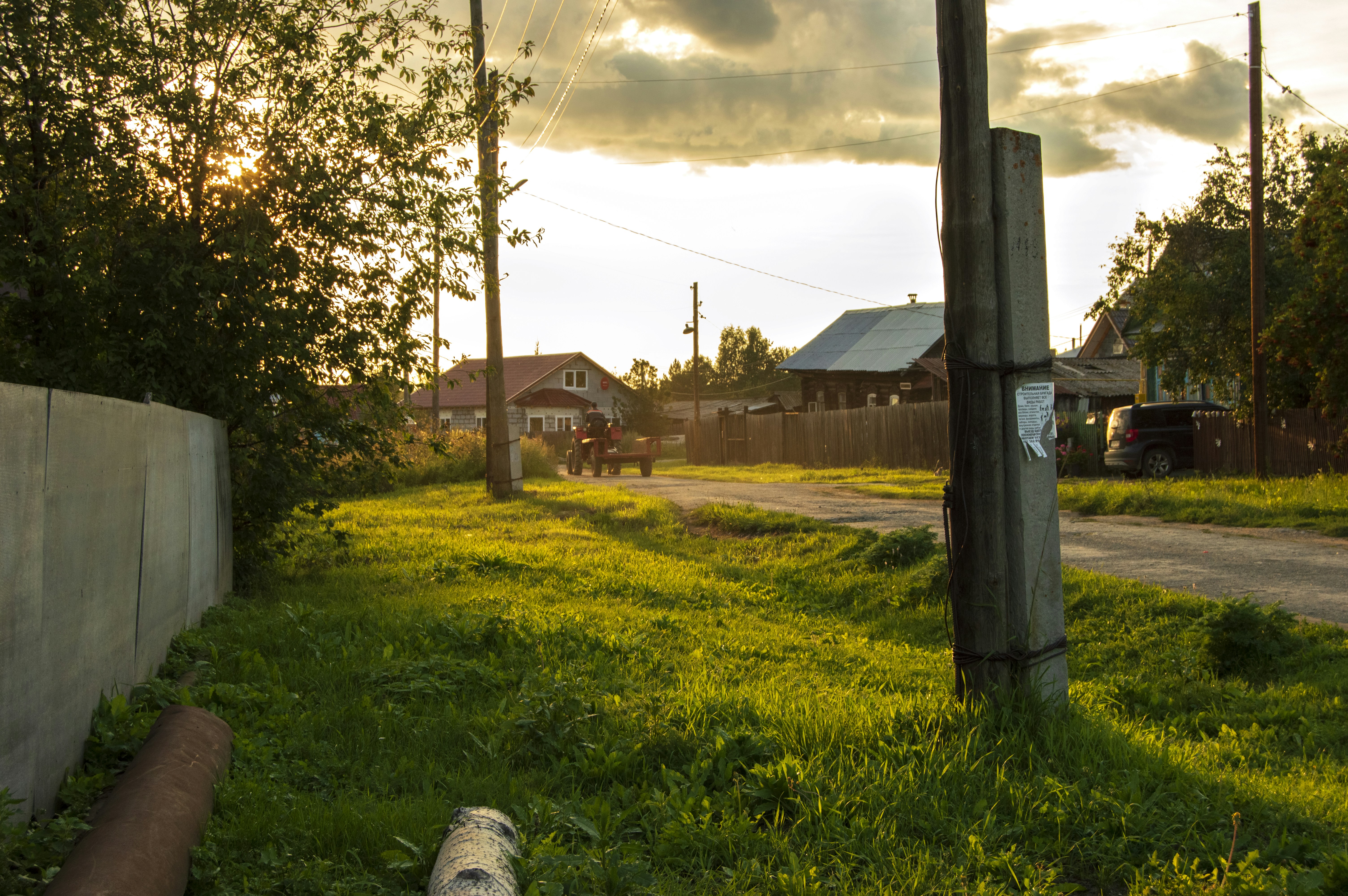 Golden Hour Verge: A Lone Figure on a Quiet Rural Street