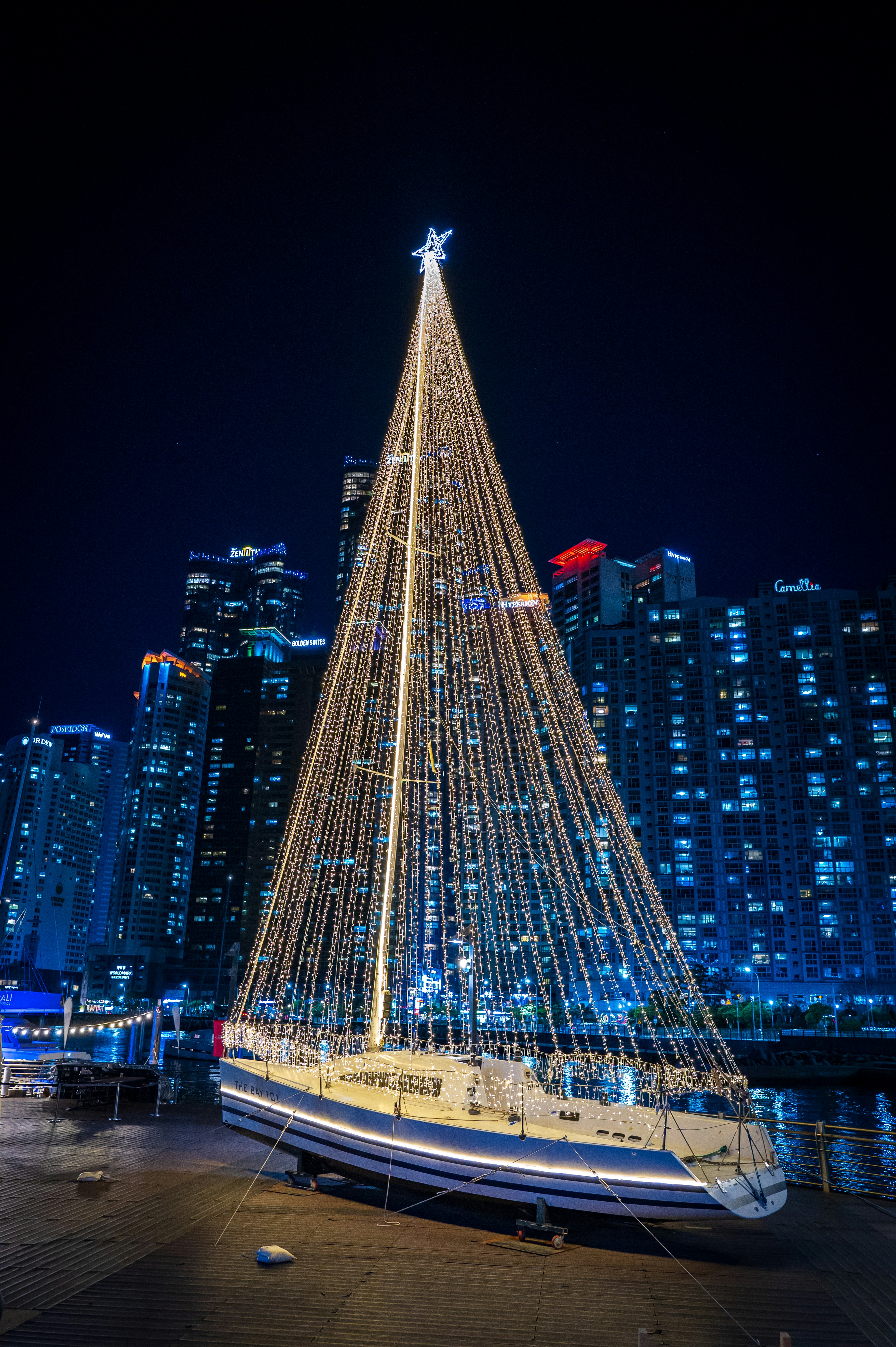 Luminous Marina Christmas Tree Rising Over Neon City