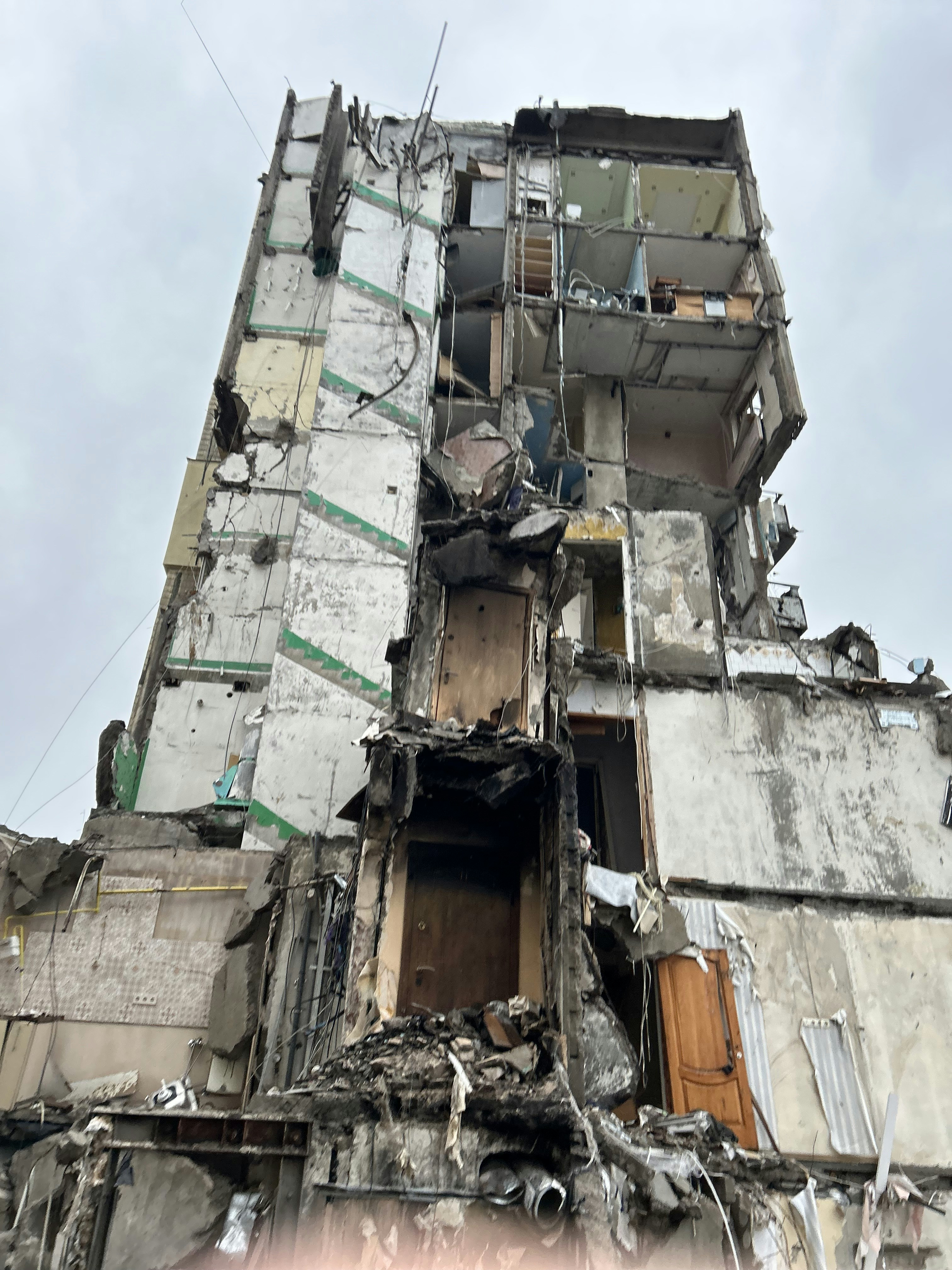 Urban Skeleton: The Crumbling Tower Exposed in Rubble