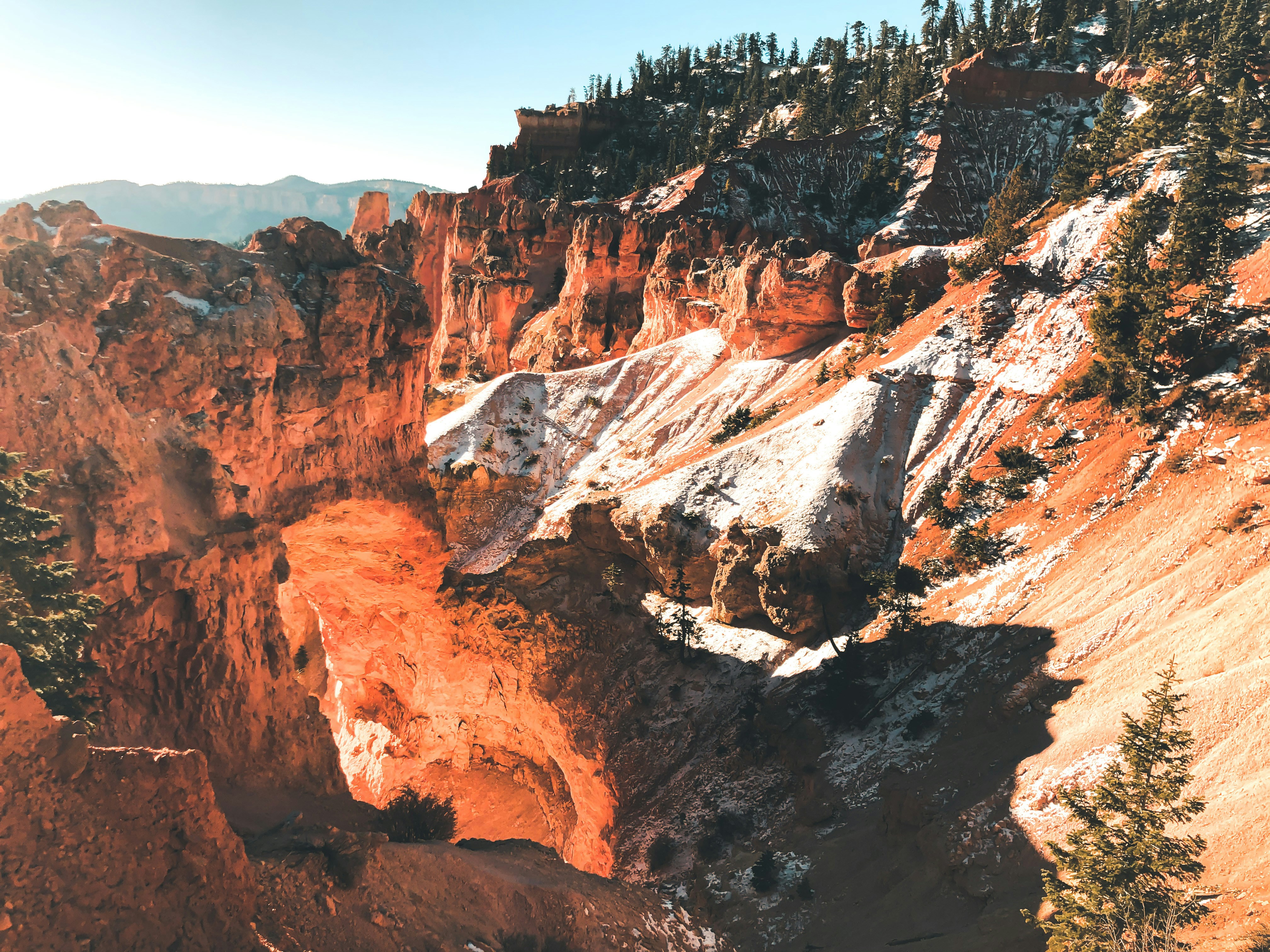 Rugged canyon sunlight: terracotta cliffs and shadowed amphitheater