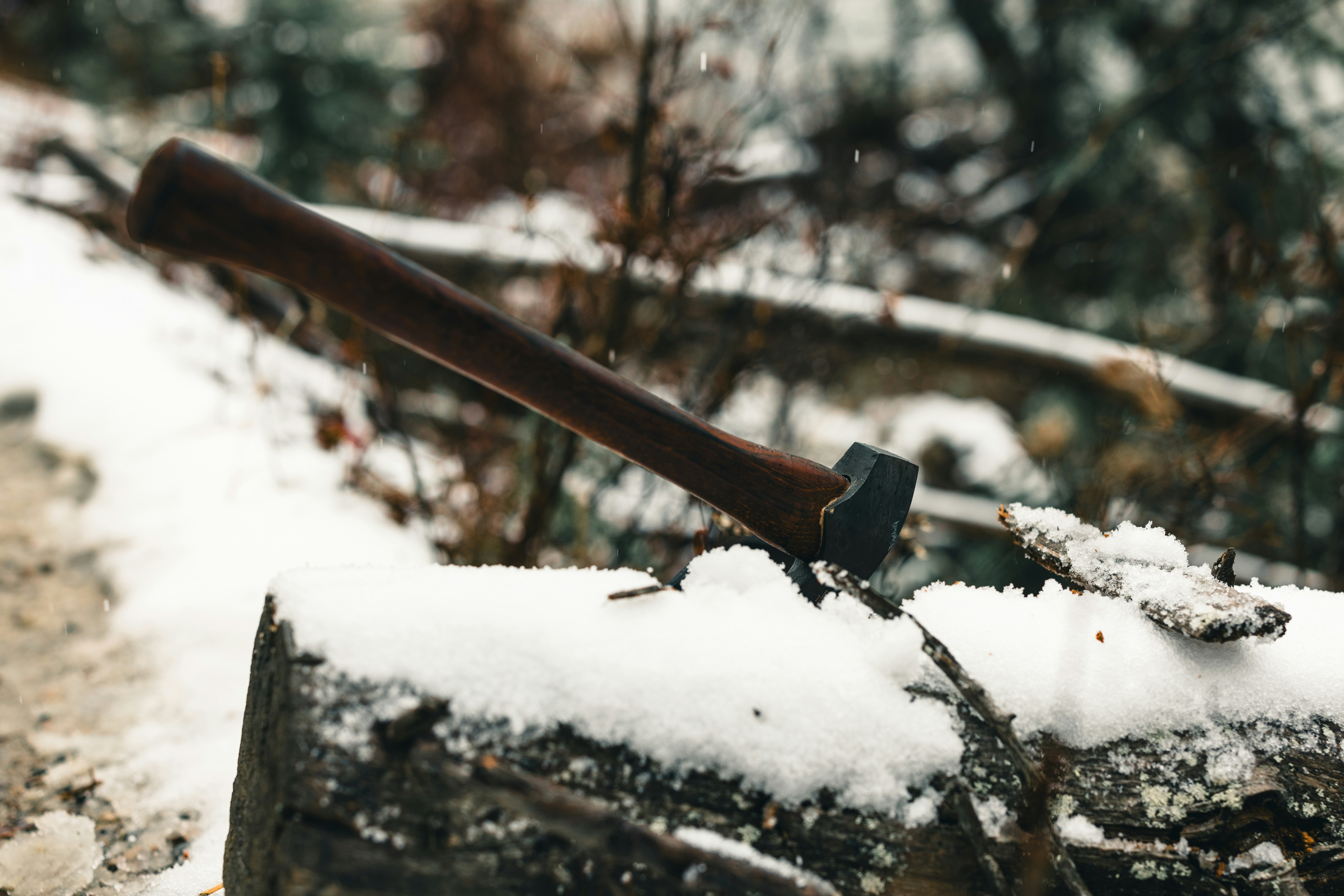 A hammer stuck in a piece of wood in the snow photo – Free Canada Image ...