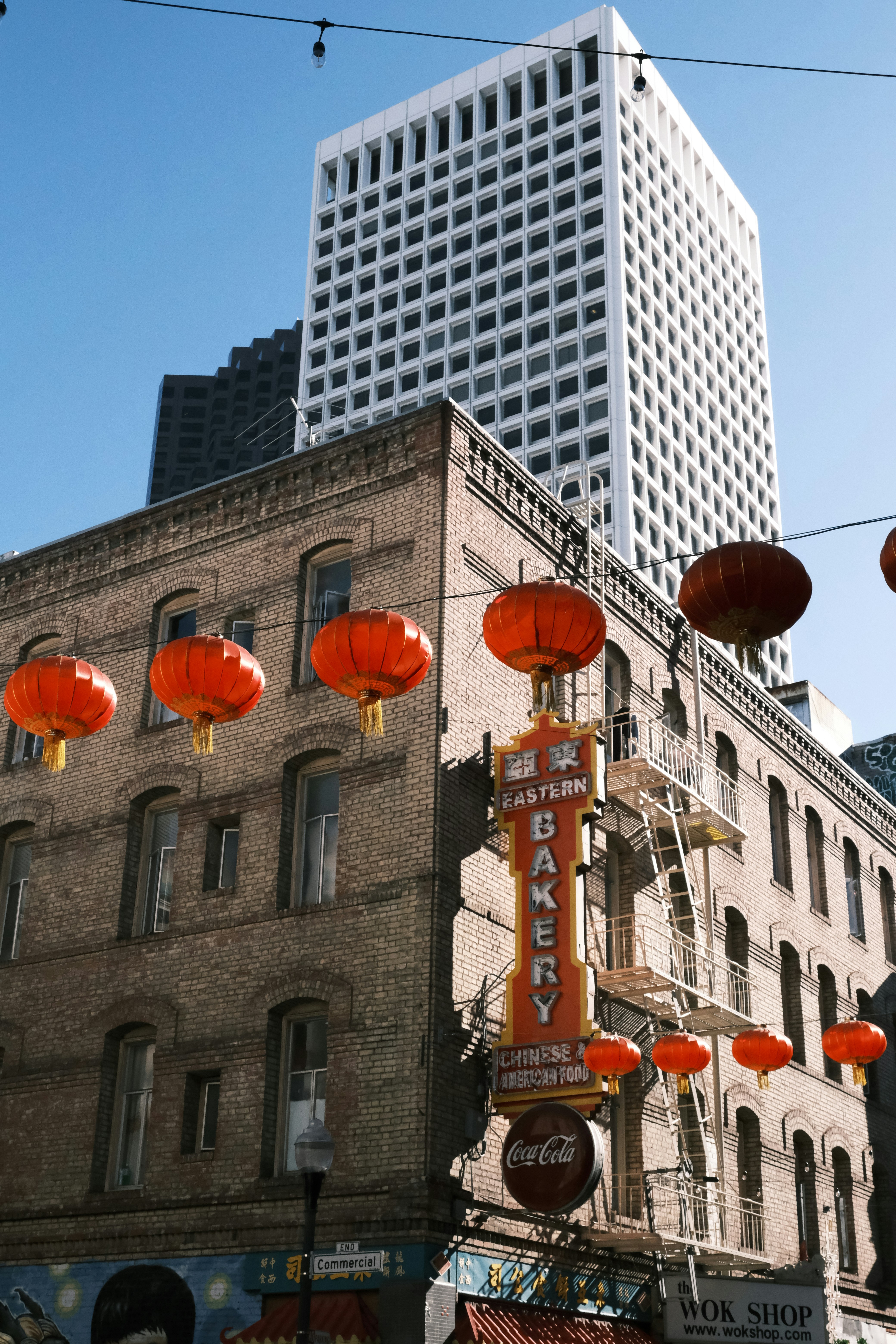 a large building with lots of red lanterns hanging from it's side
