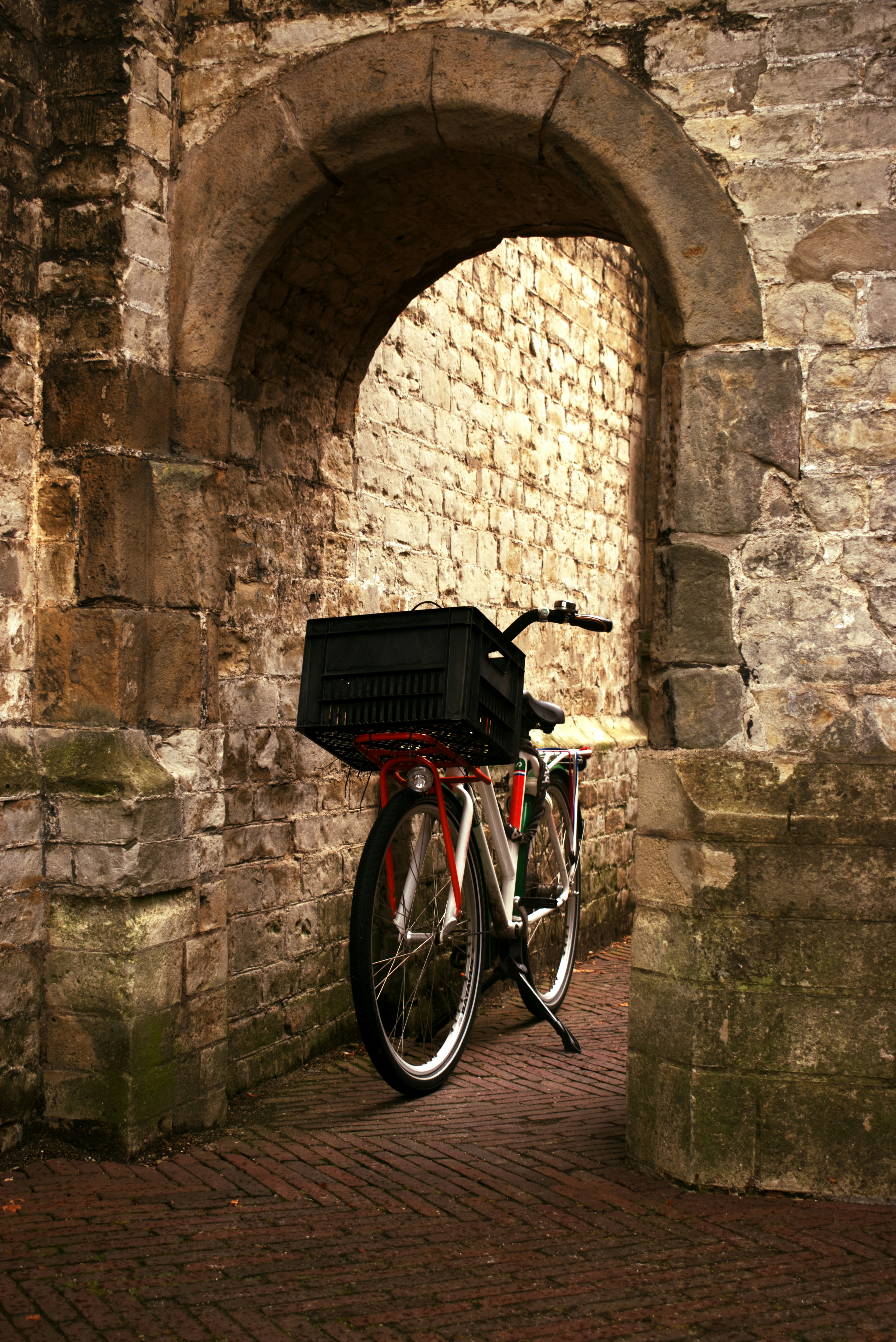 Archway Courier: Front-Cargo Bicycle in a Time-Worn Stone Passage