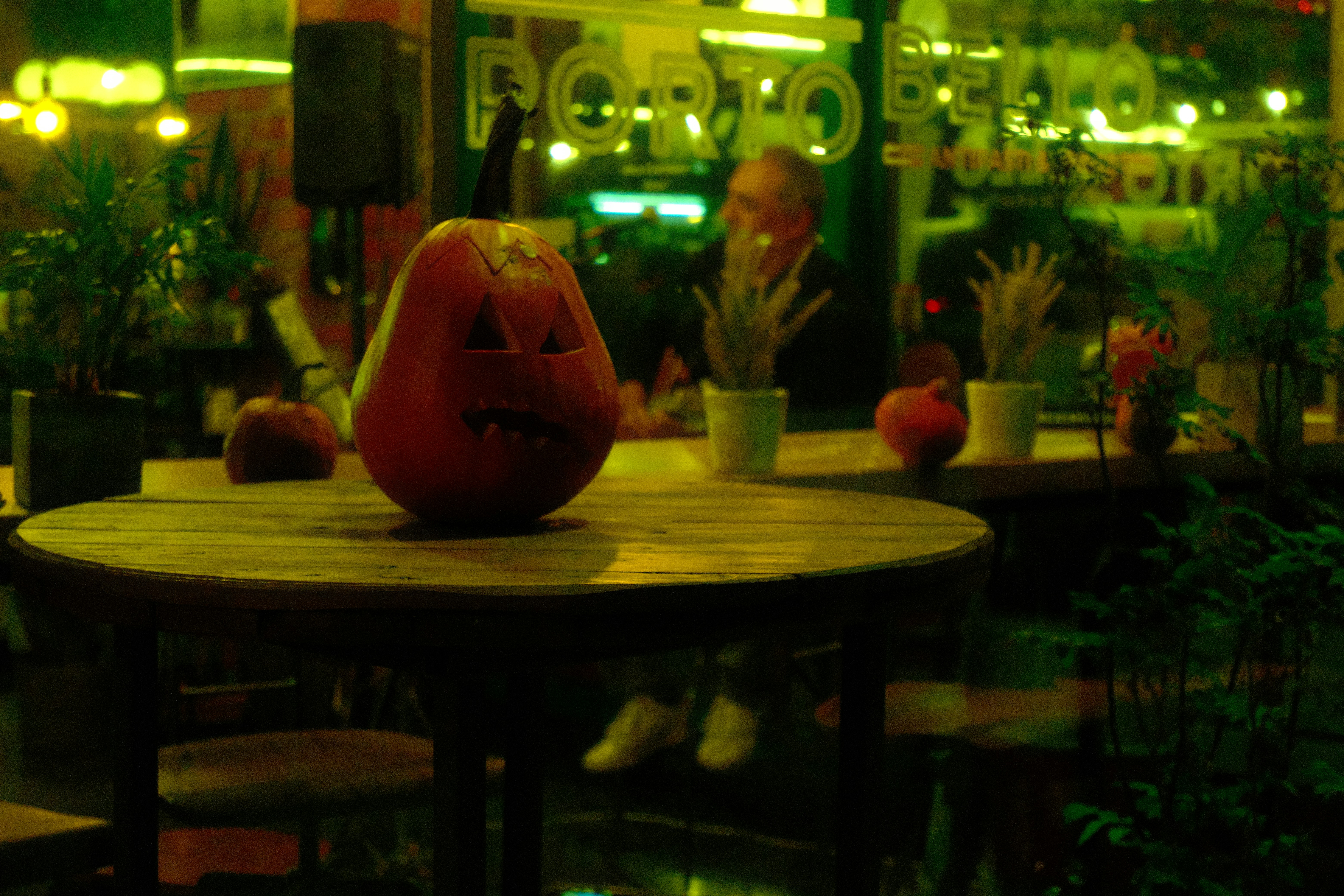 Halloween Pumpkin on a Table in a Dim Café Window