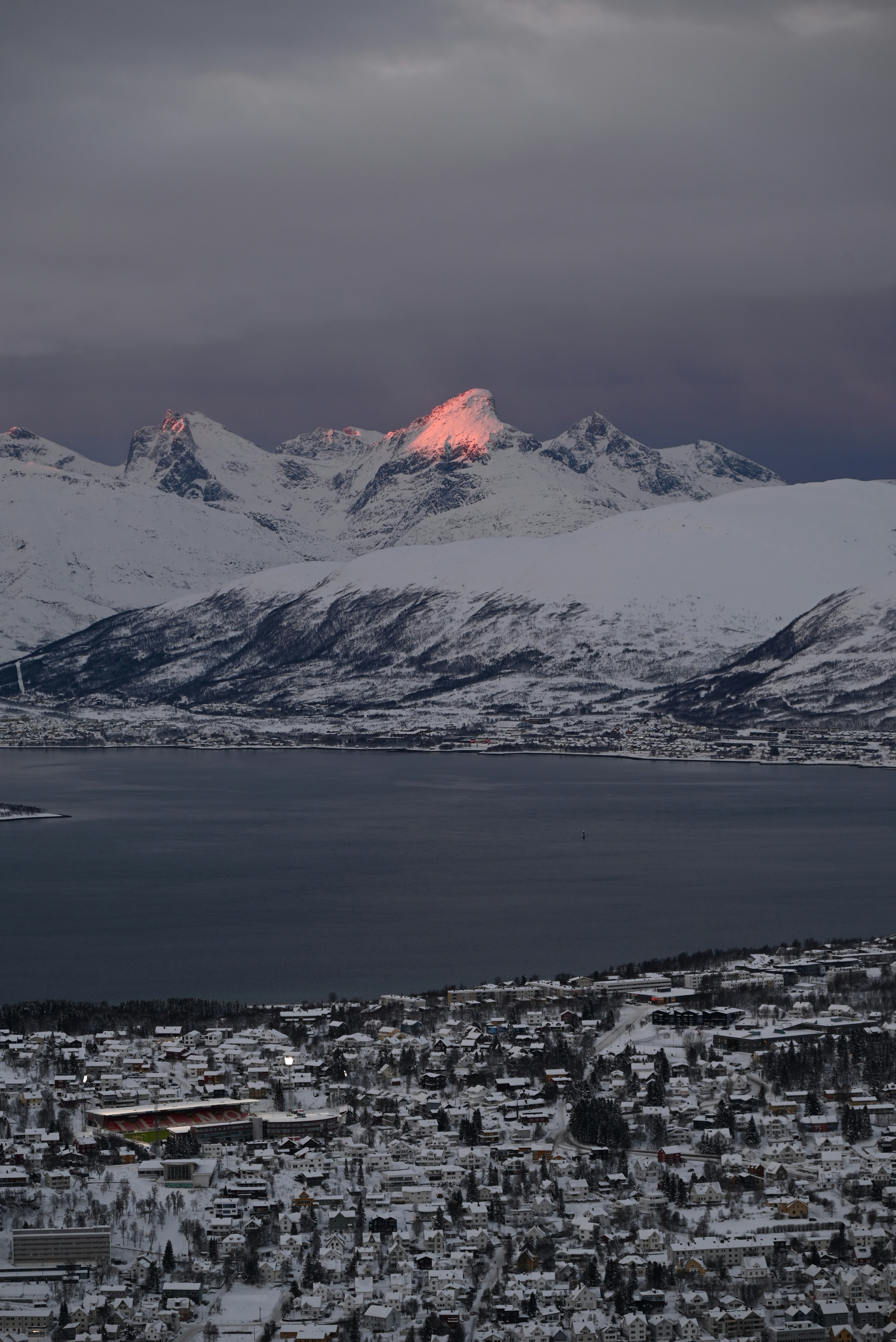 Twilight Peak: Coral Glow Over a Snowbound Fjord Town