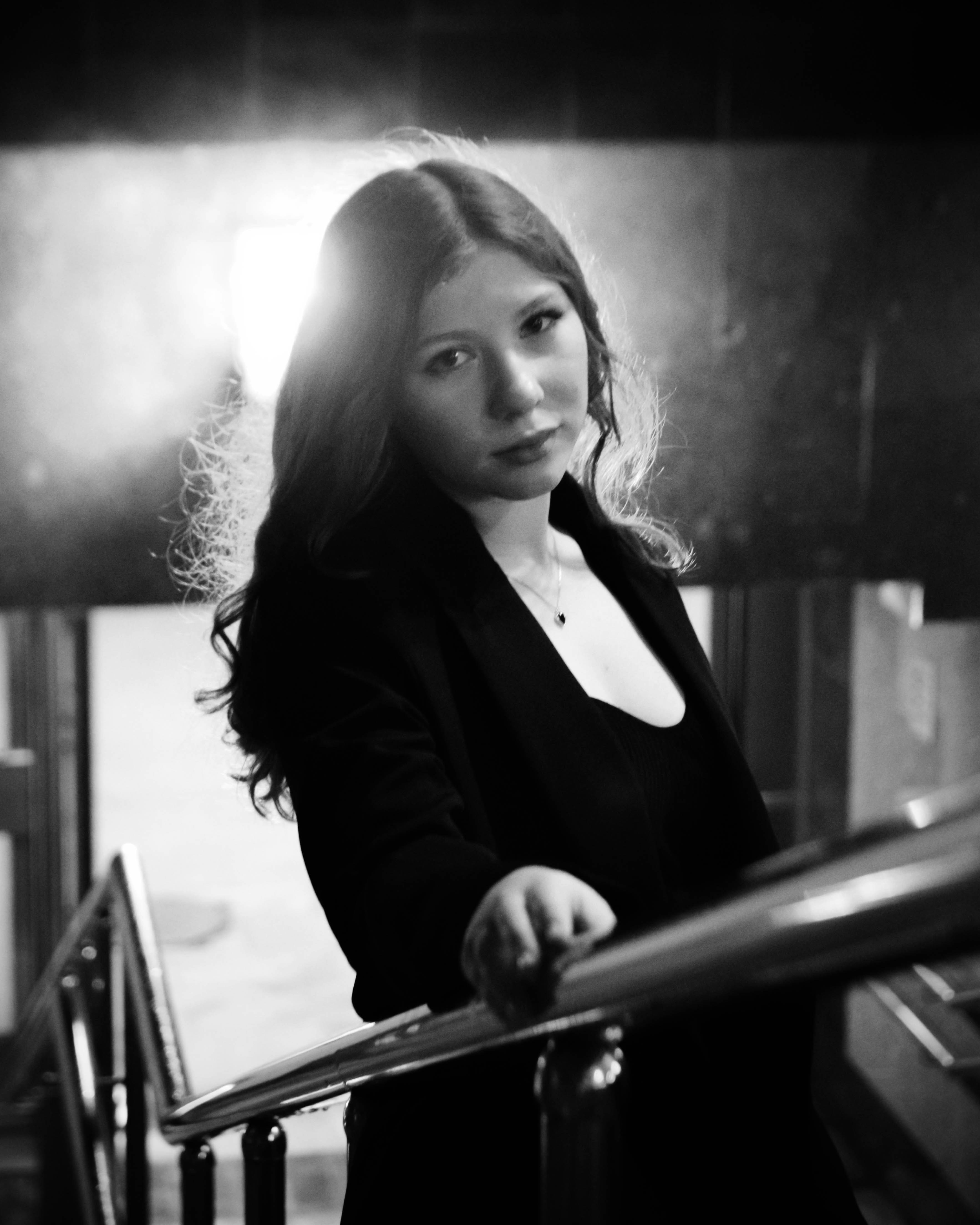 A woman in a suit is standing on a stair case photo – Free Russia Image ...
