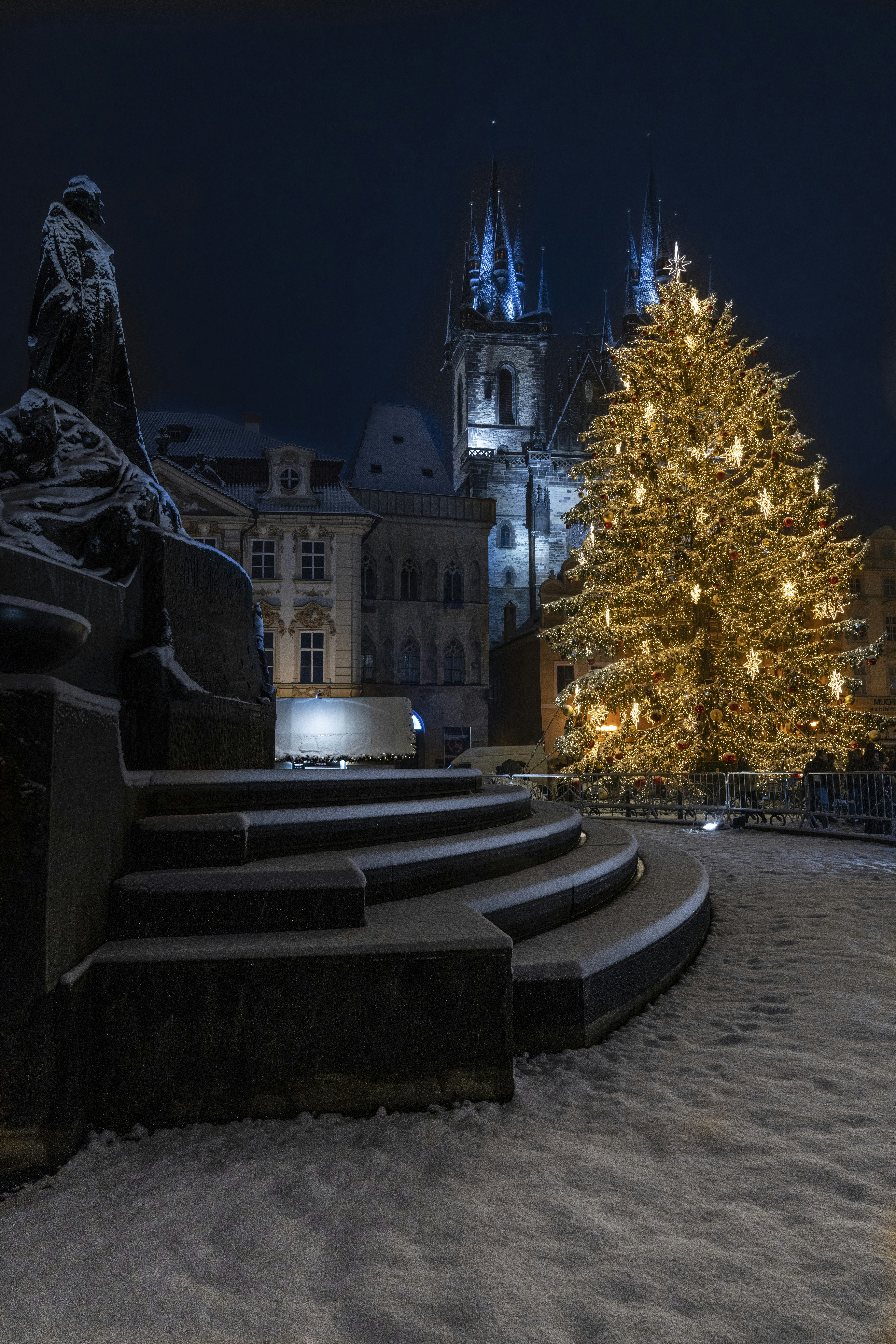 Luminous Noel: Christmas Tree Framed by Gothic Spires over a Snowy Square