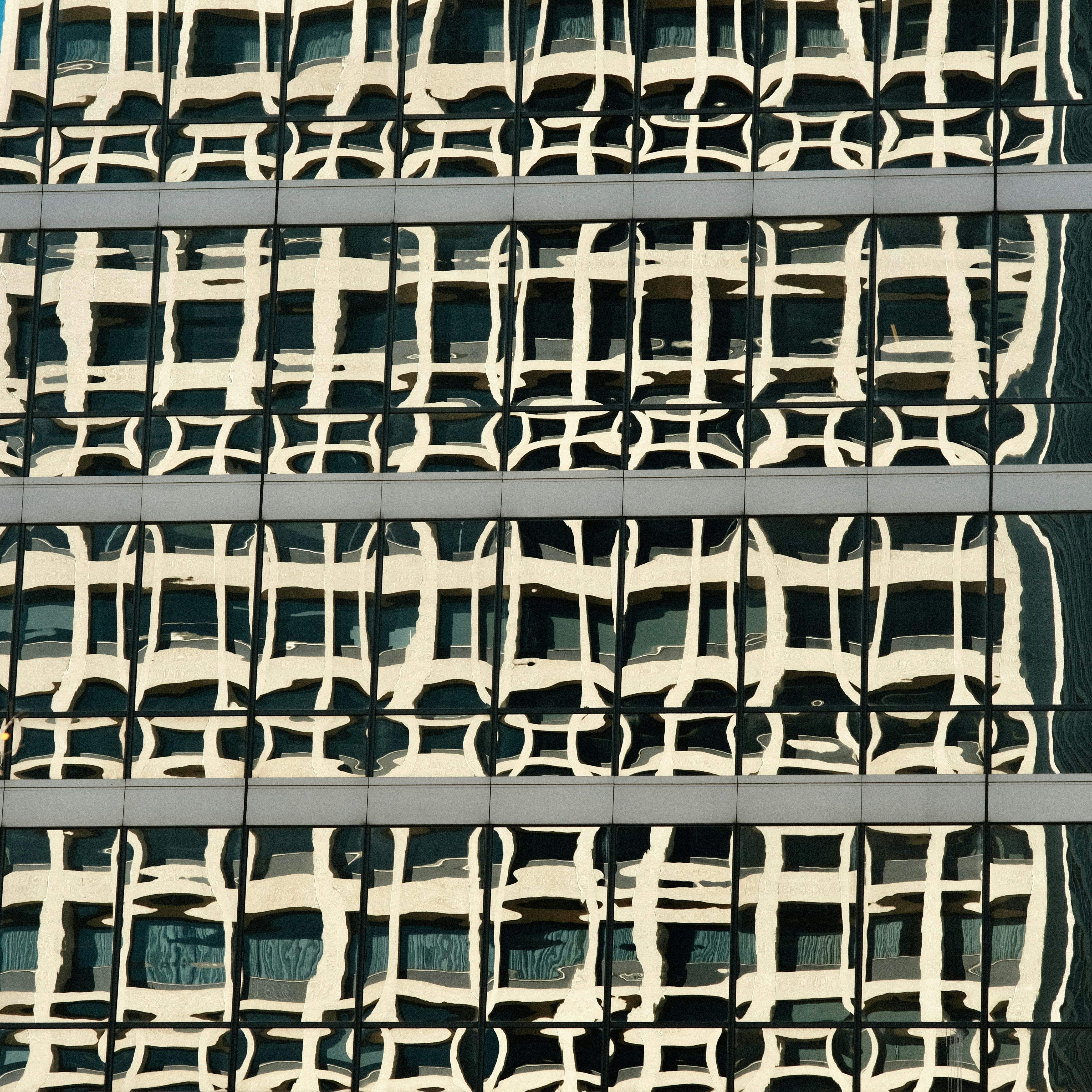 Warped Gridscape: Reflections Across a Paneled Glass Facade