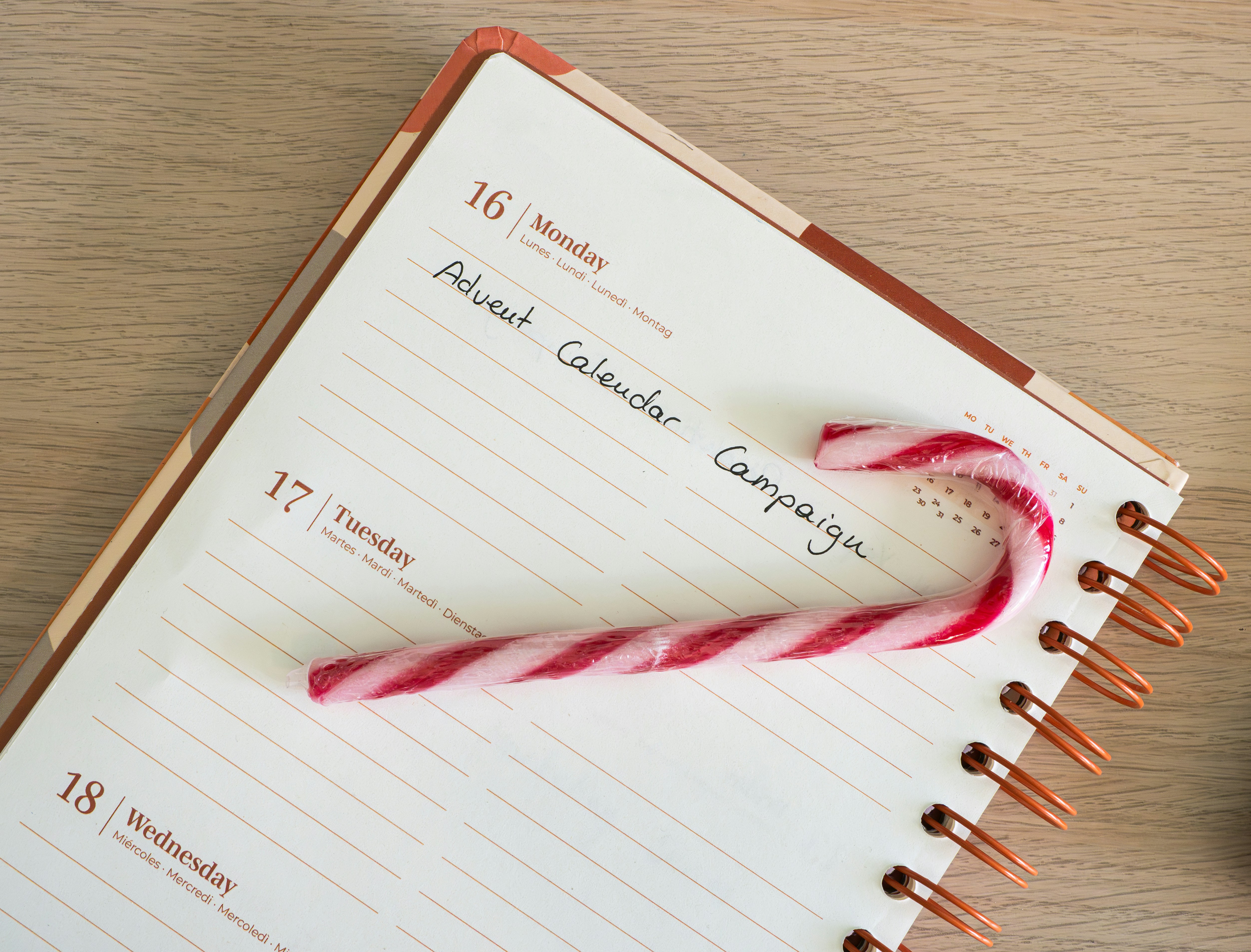 A spiral notebook with a candy cane on top of it photo – Free Desk ...