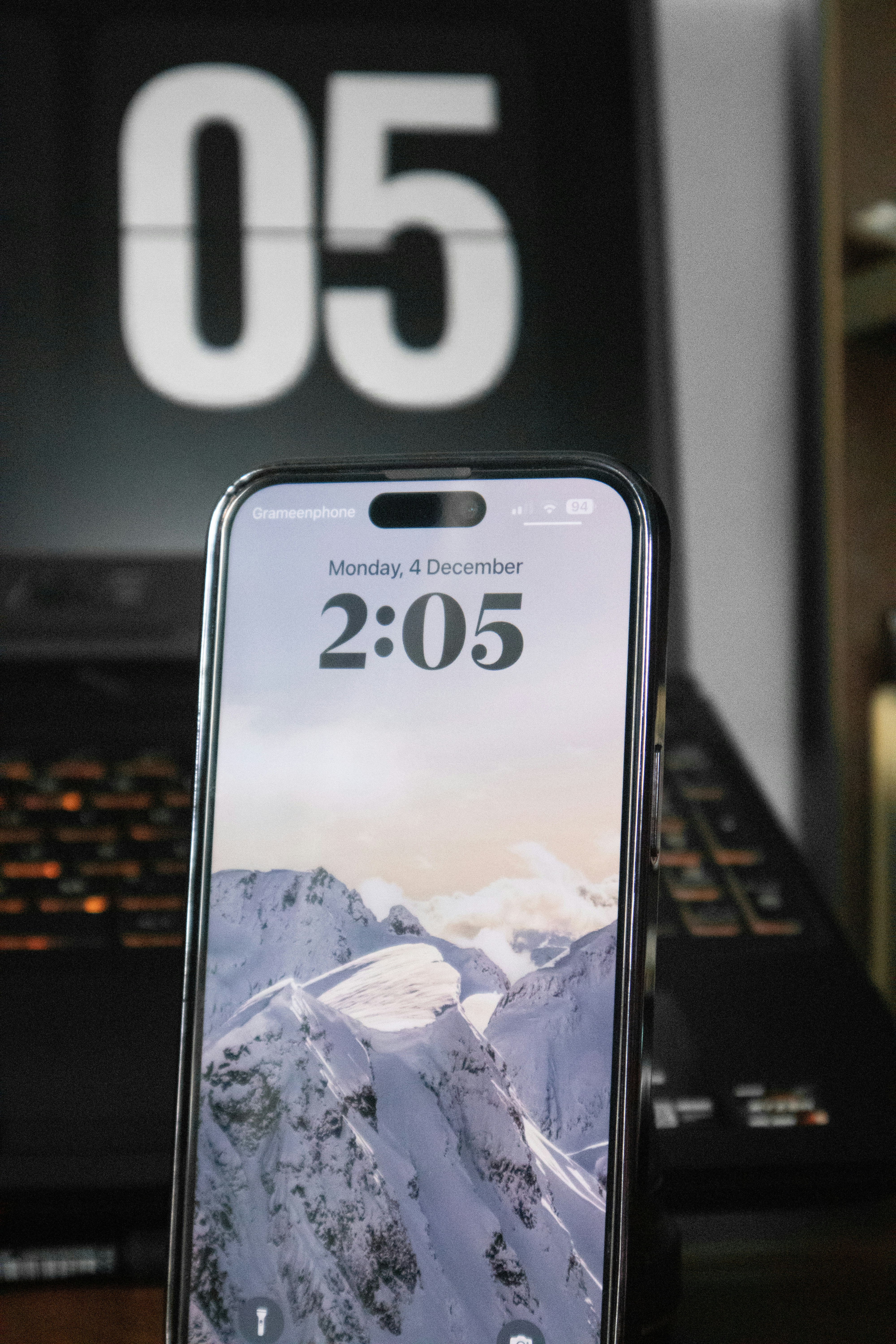 Phone on a Standby Mountain Scene: A Clock Face Reflected in Glass
