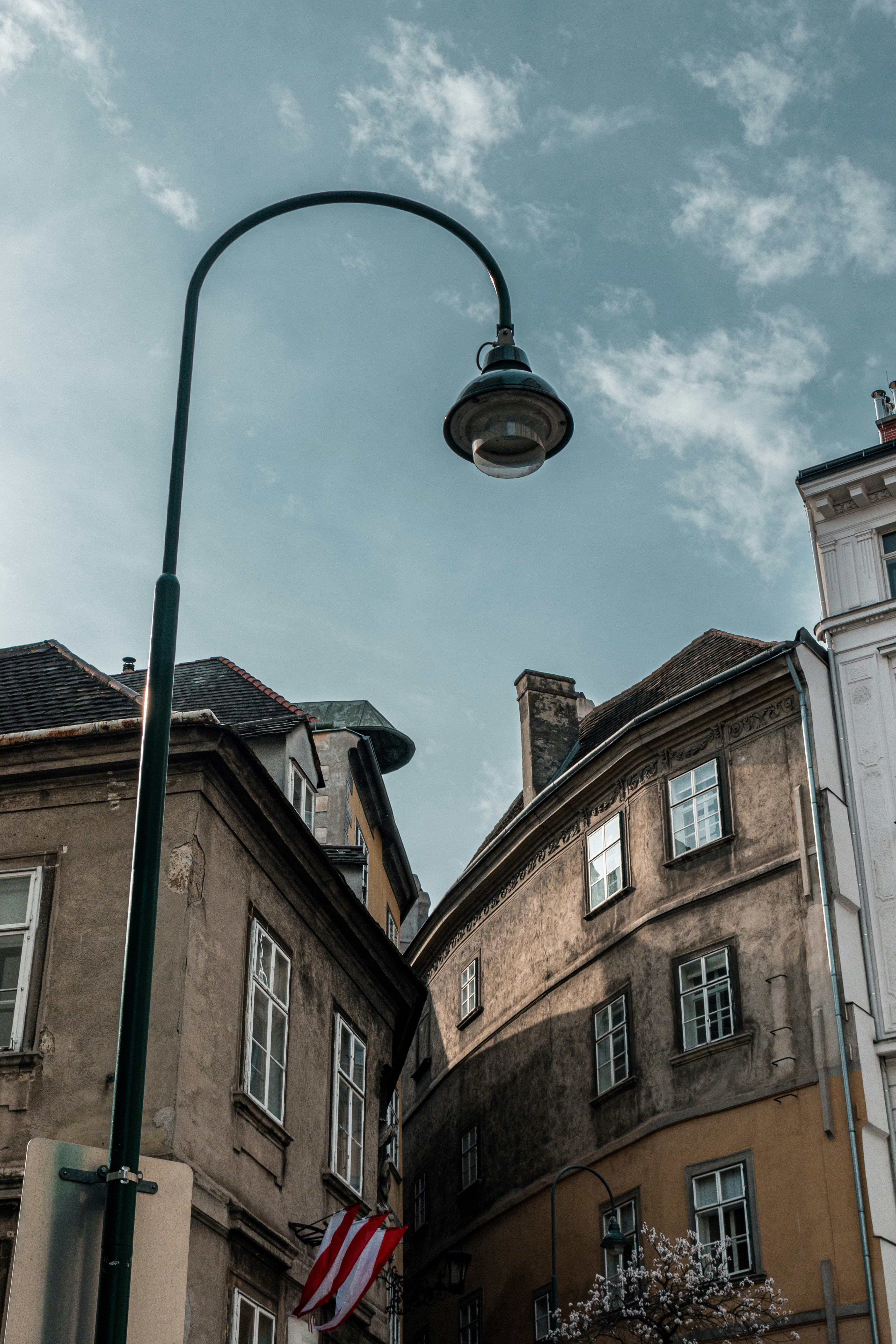 Arched Streetlamp Over Timeworn Townhouses Under a Clear Sky