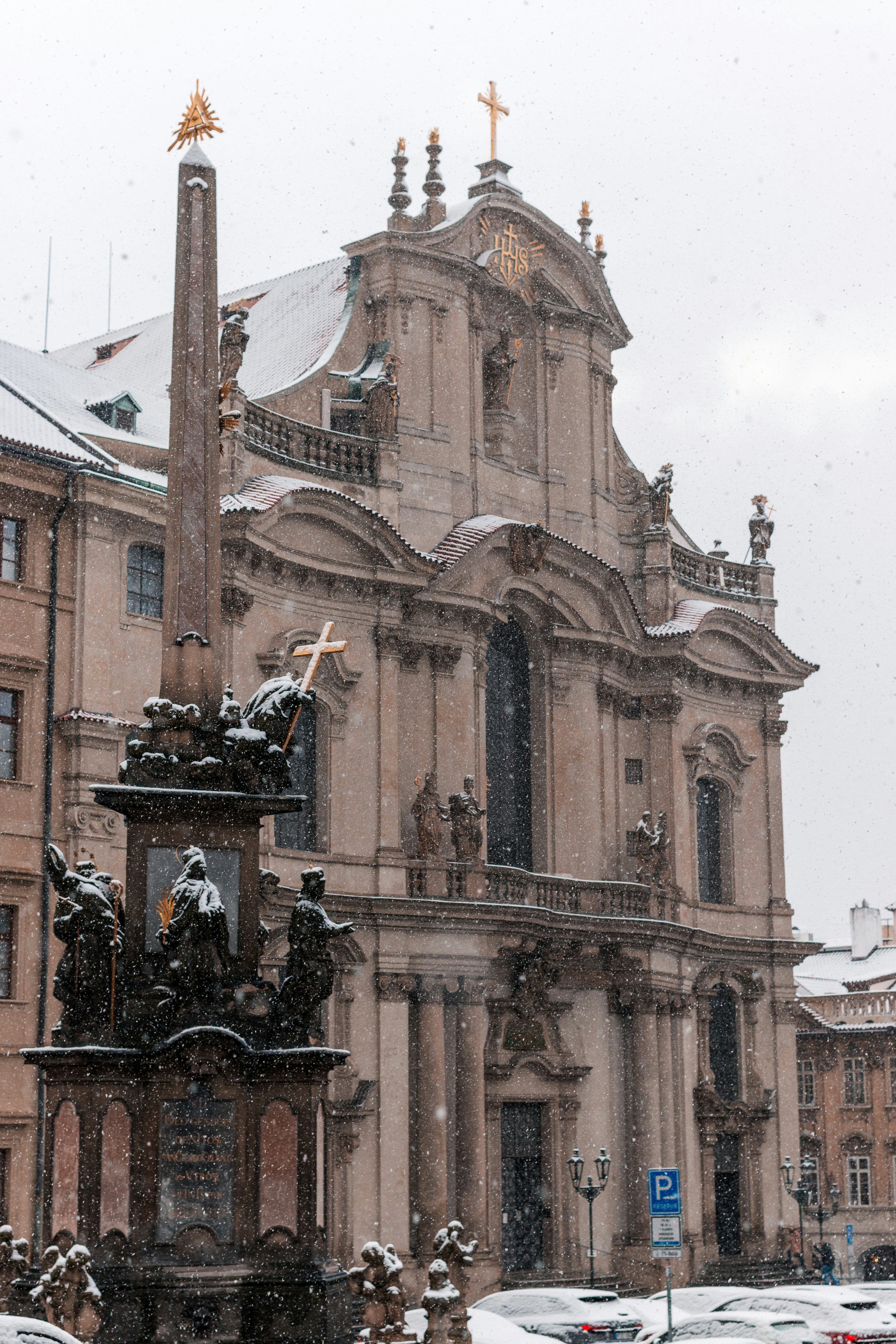Winter Veil over Baroque Cathedral: Cross, Statues, and Snowfall