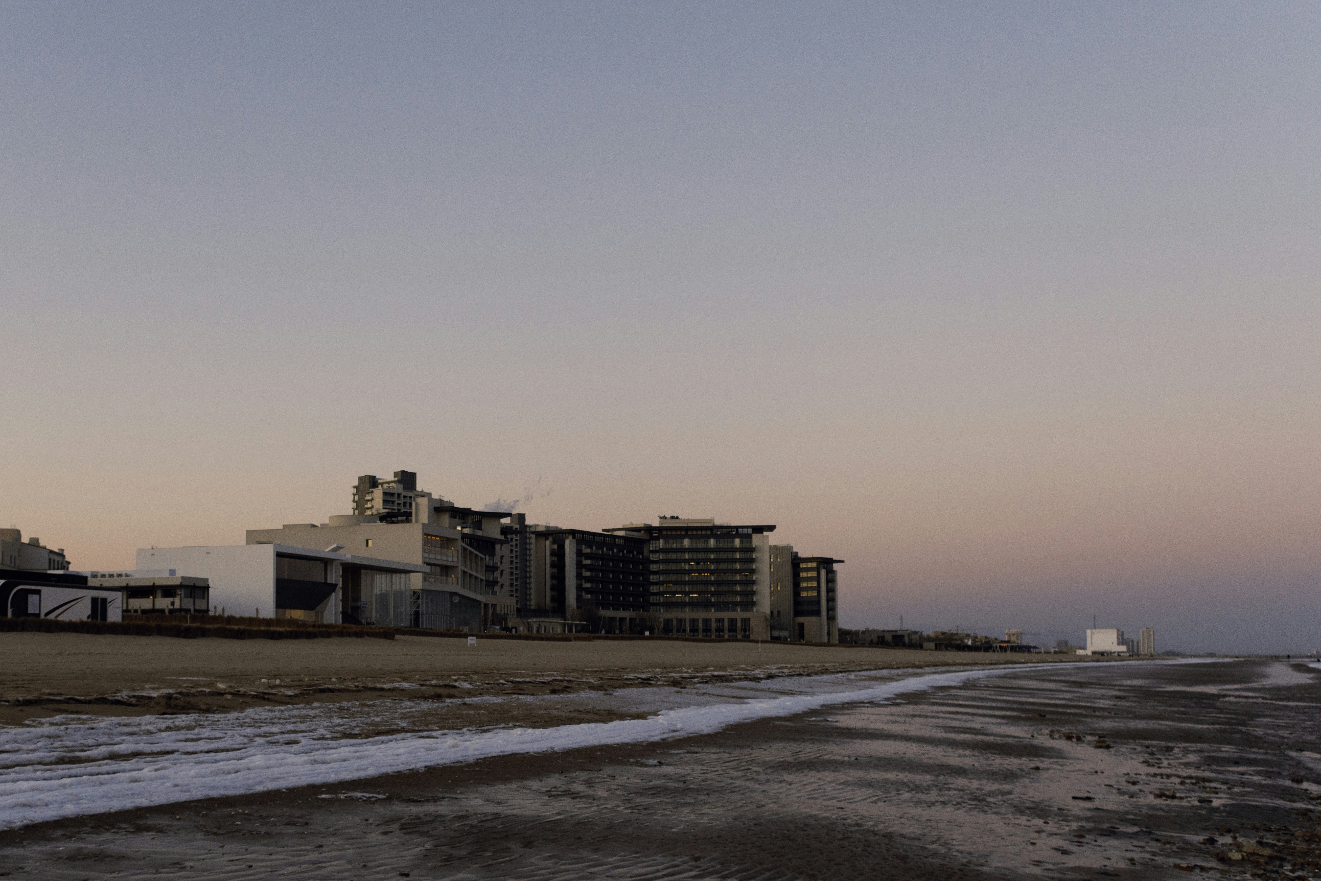 Horizon in Frost: Modern Blocks at the Edge of a Quiet Winter Beach