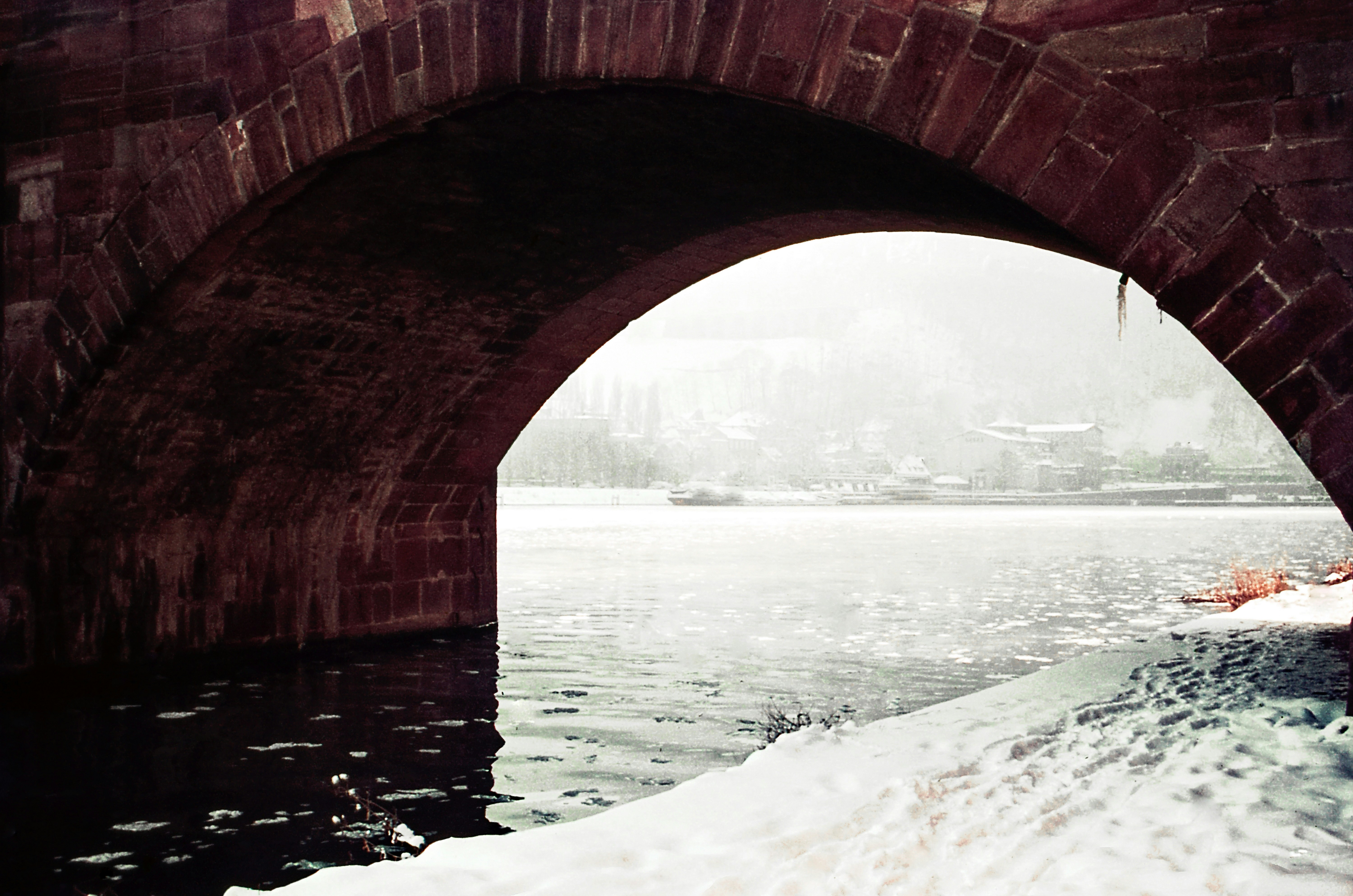 A boat is going under a bridge in the snow photo – Free Heidelberg ...