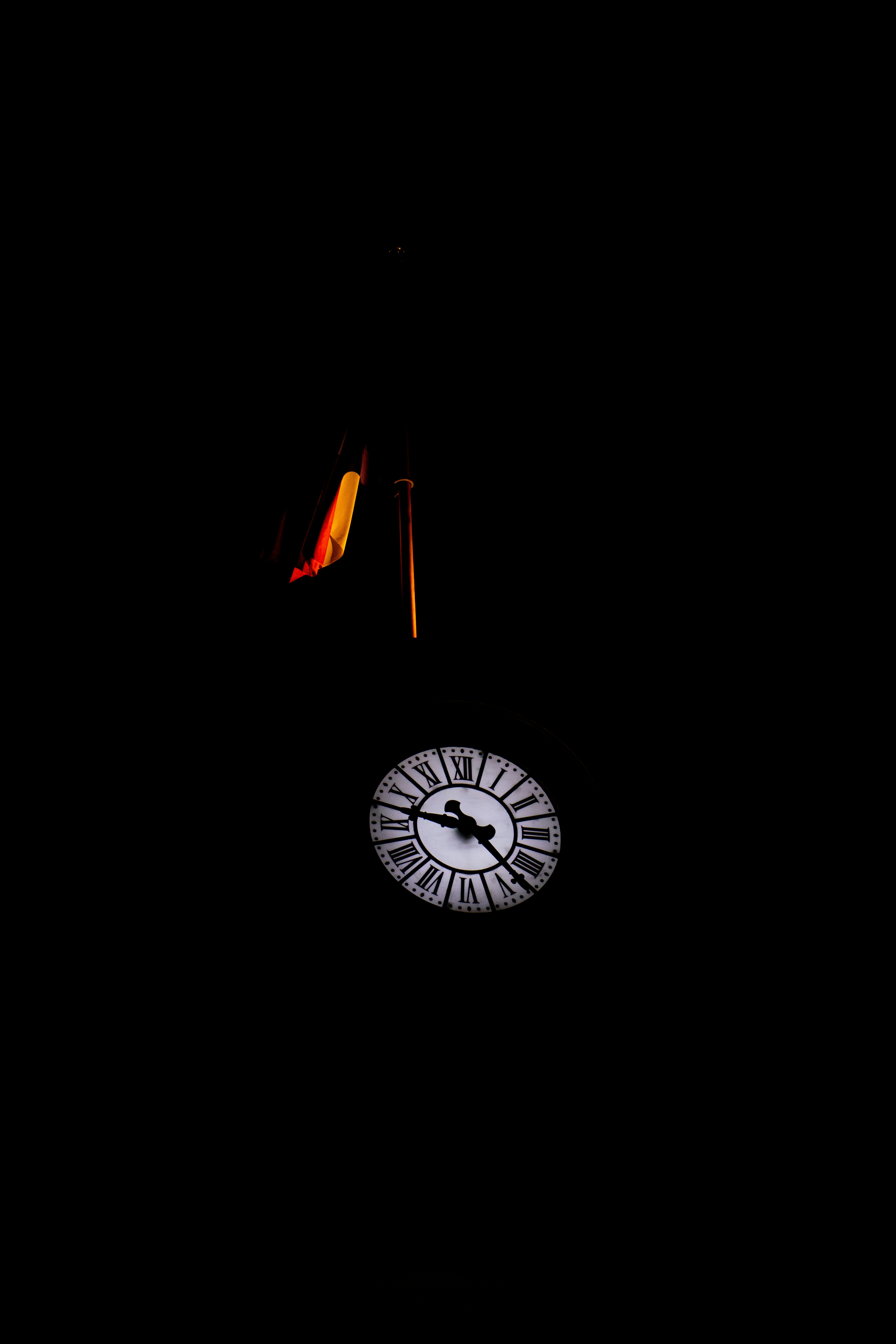 Amber Dial in the Night: A Clock Face Emerges from Darkness