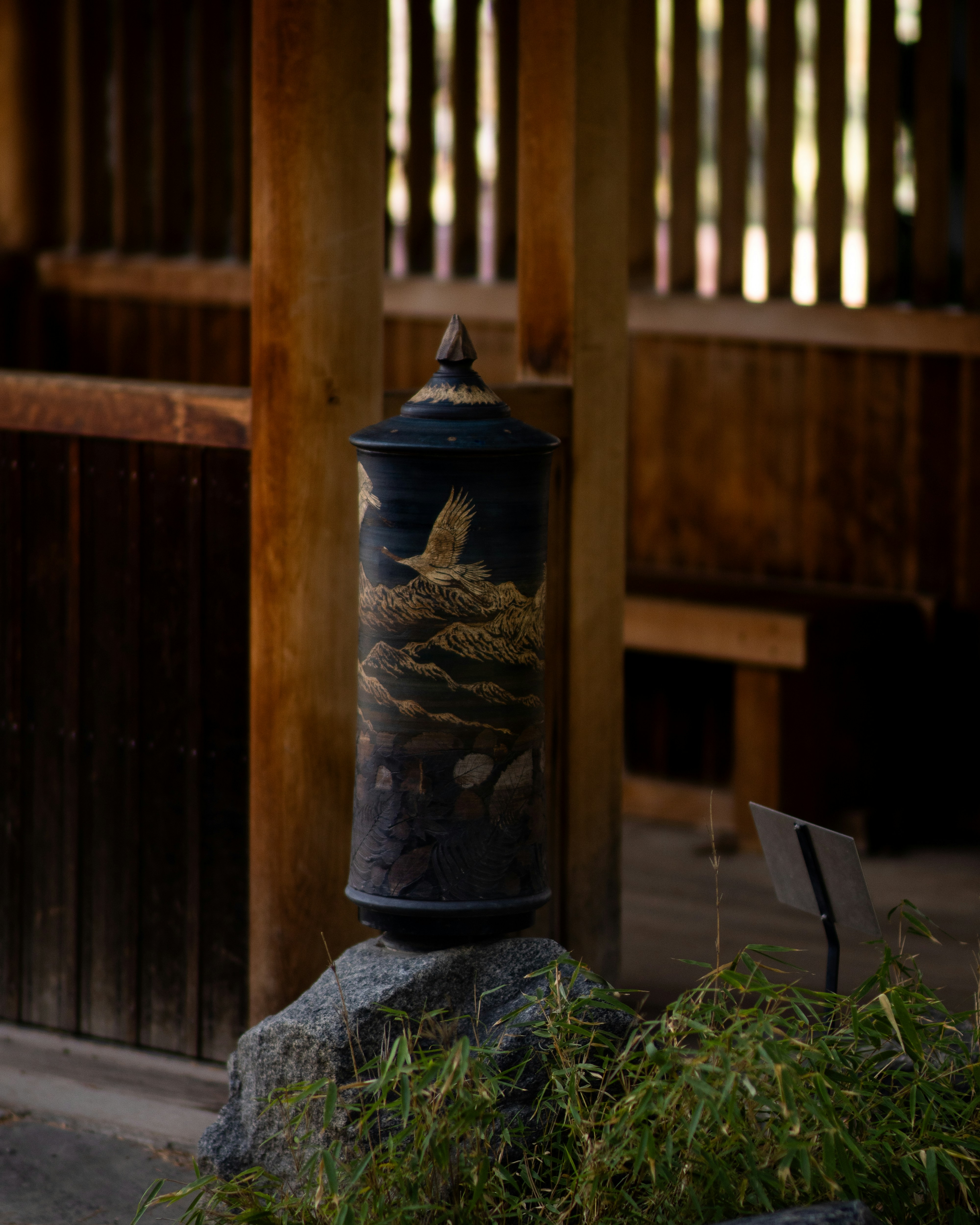 Bird over Peaks: A lacquered vessel guarding a temple alcove