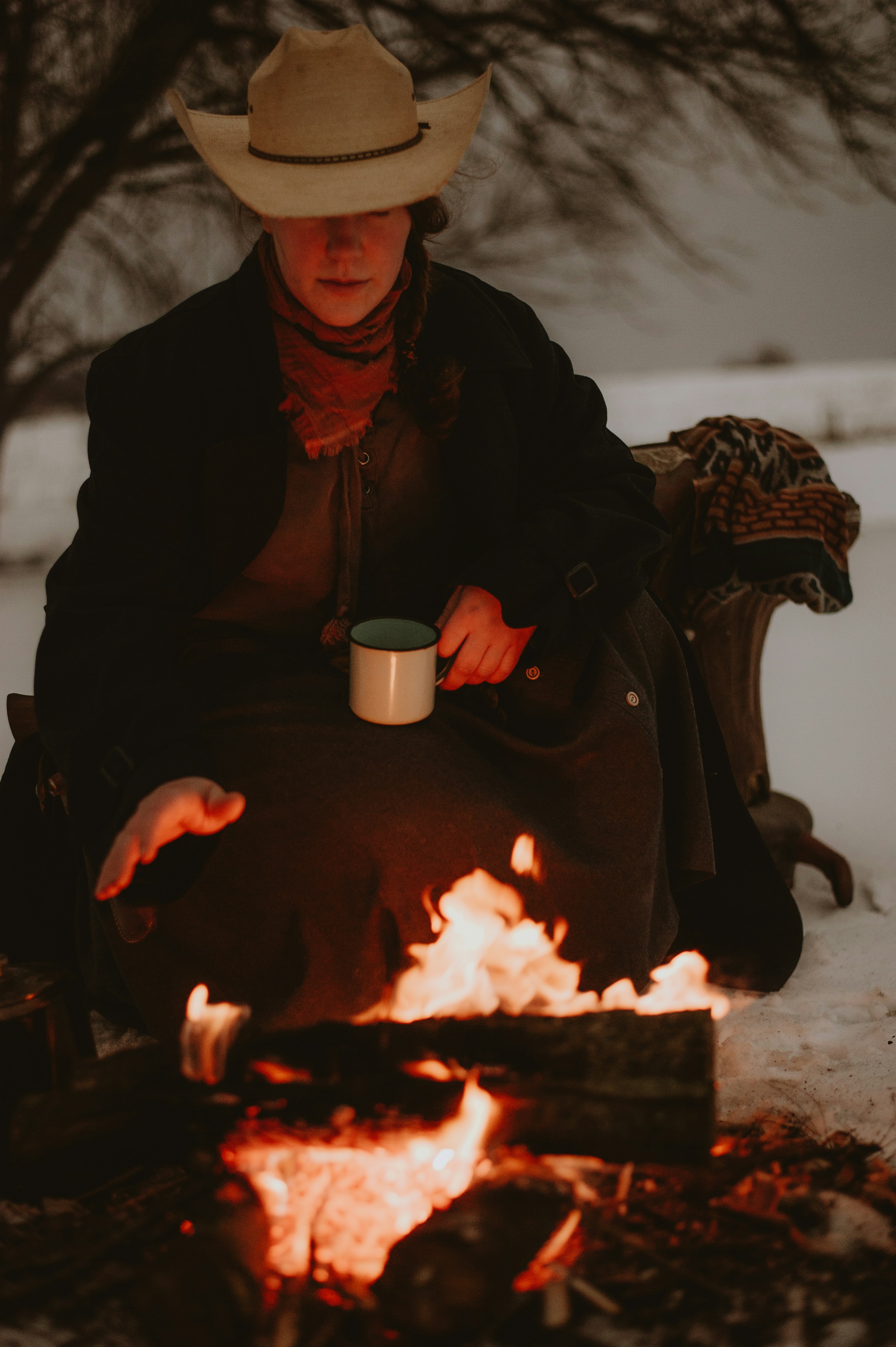 Hearthside Cowboy: Quiet Warmth by the Snowlit Fire