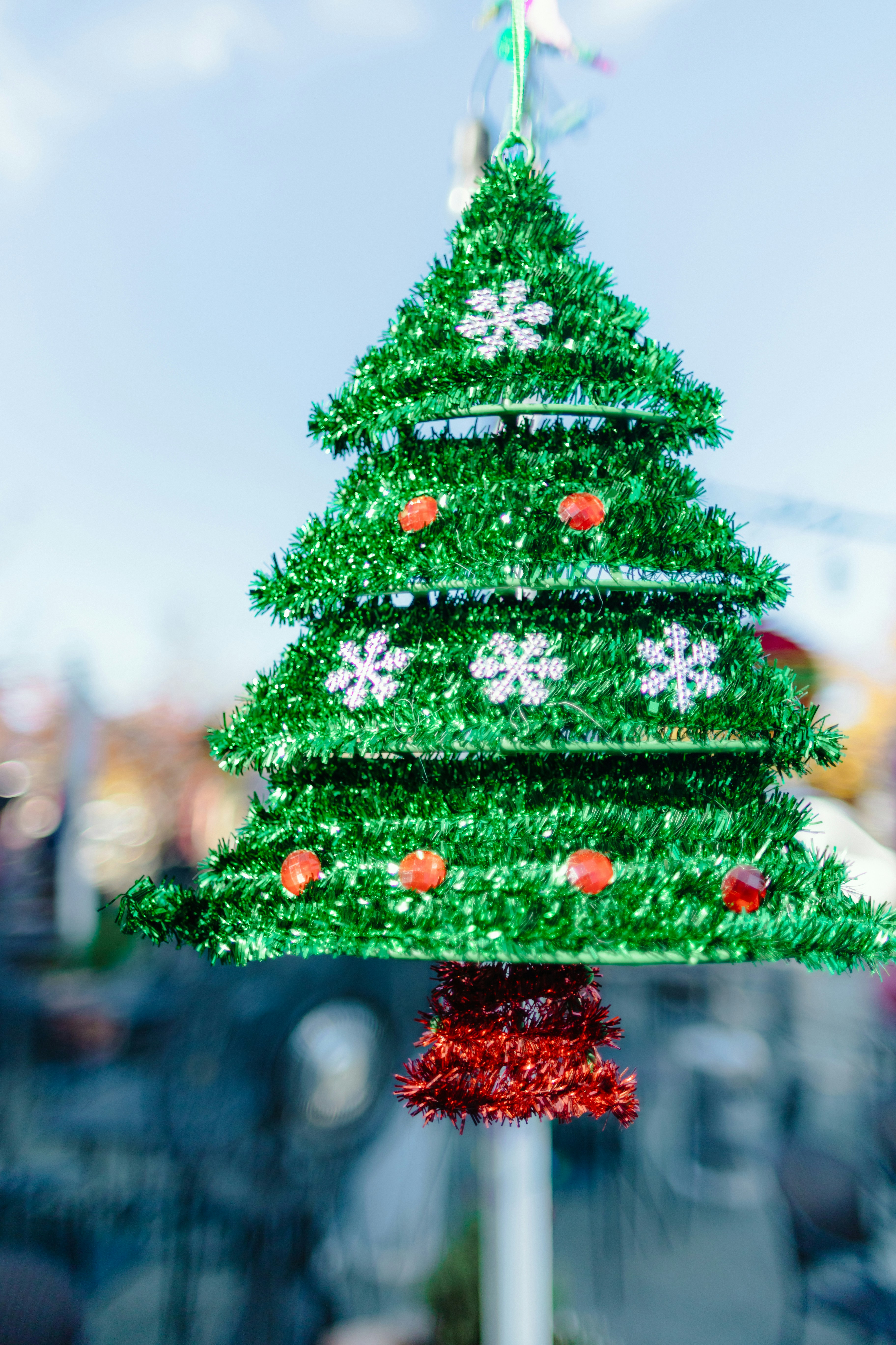 Glittering Green Pyramid: A Tinsel Christmas Tree in Focus