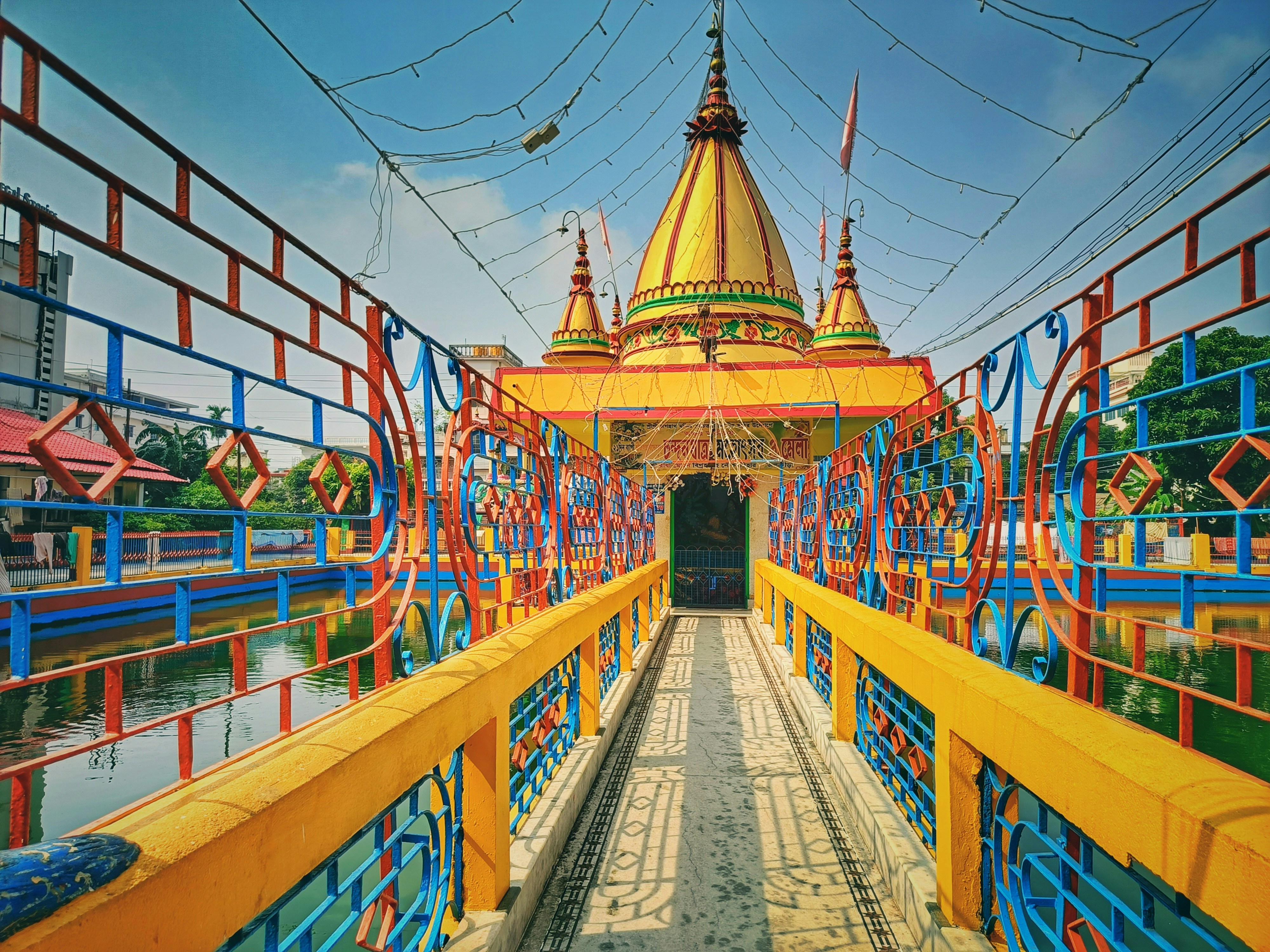 A brightly colored bridge over a body of water photo – Free Palace ...