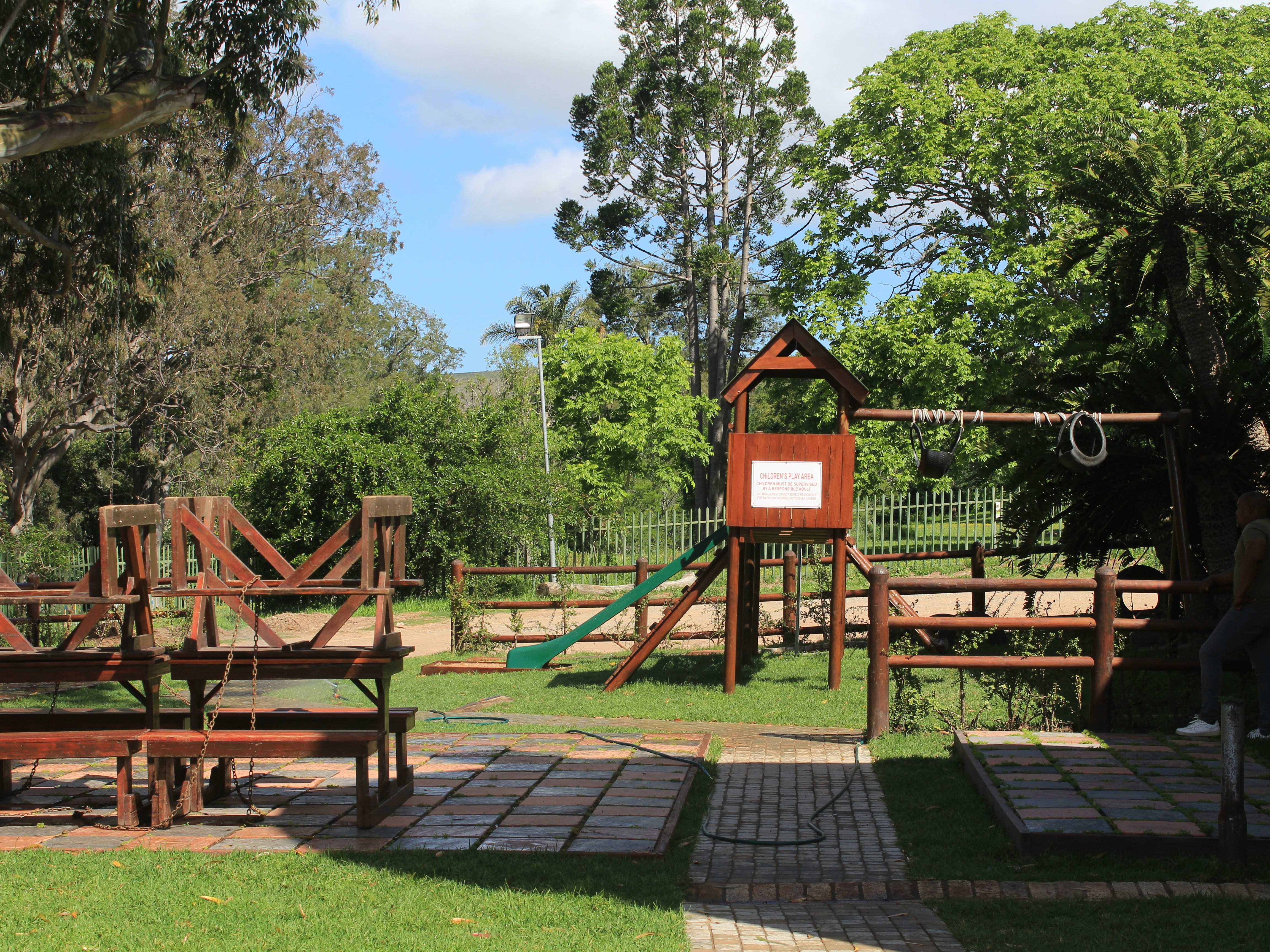 Sunlit Cedar Playhouse in a Quiet Park